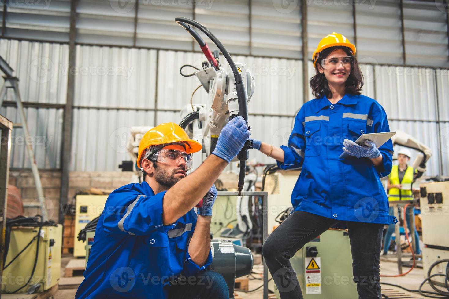 Two Engineers Mechanic Using Computer Controller Robotic Arm For