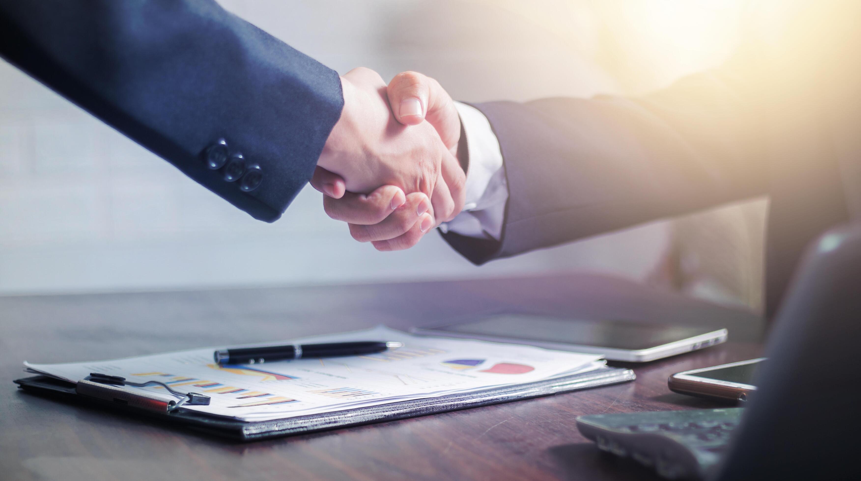 Two businessmen shake hands to celebrate a business deal 1103222 Stock ... Two businessmen shake hands to celebrate a business deal 1103222 Stock ...