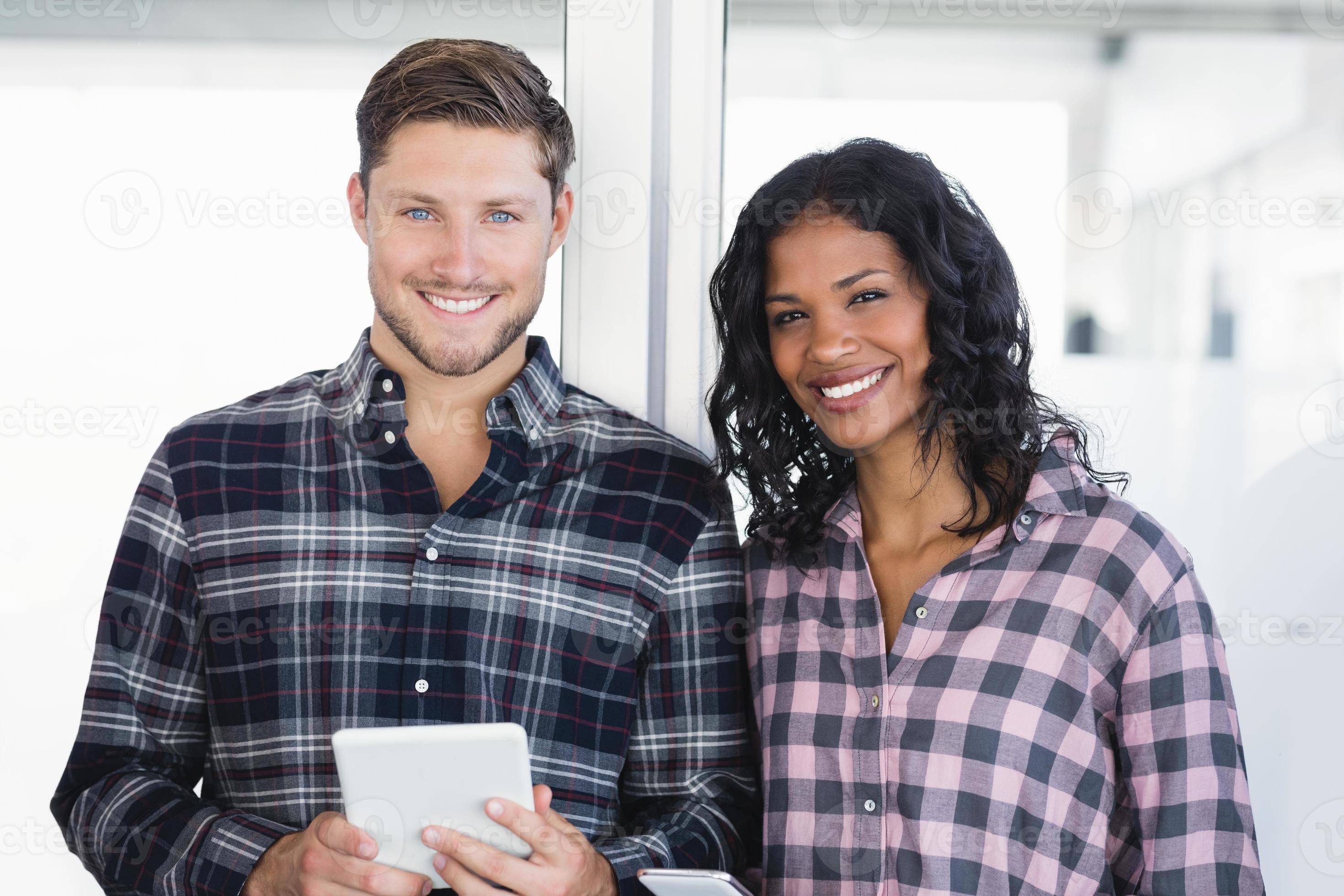 Portrait of smiling business colleagues holding digital tablet 1179132 ... Portrait of smiling business colleagues holding digital tablet 1179132 ...