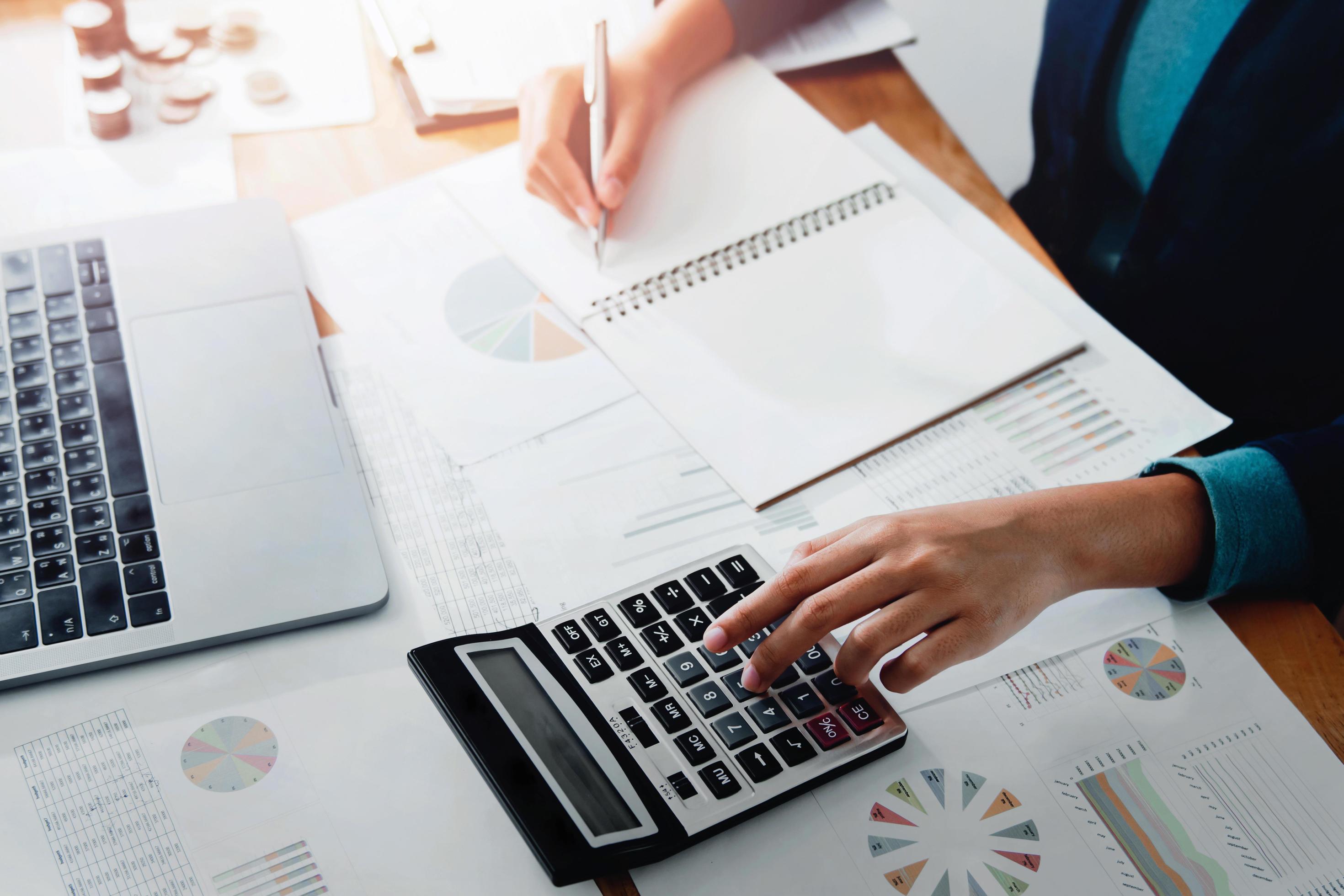 Person using calculator 1309841 Stock Photo at Vecteezy