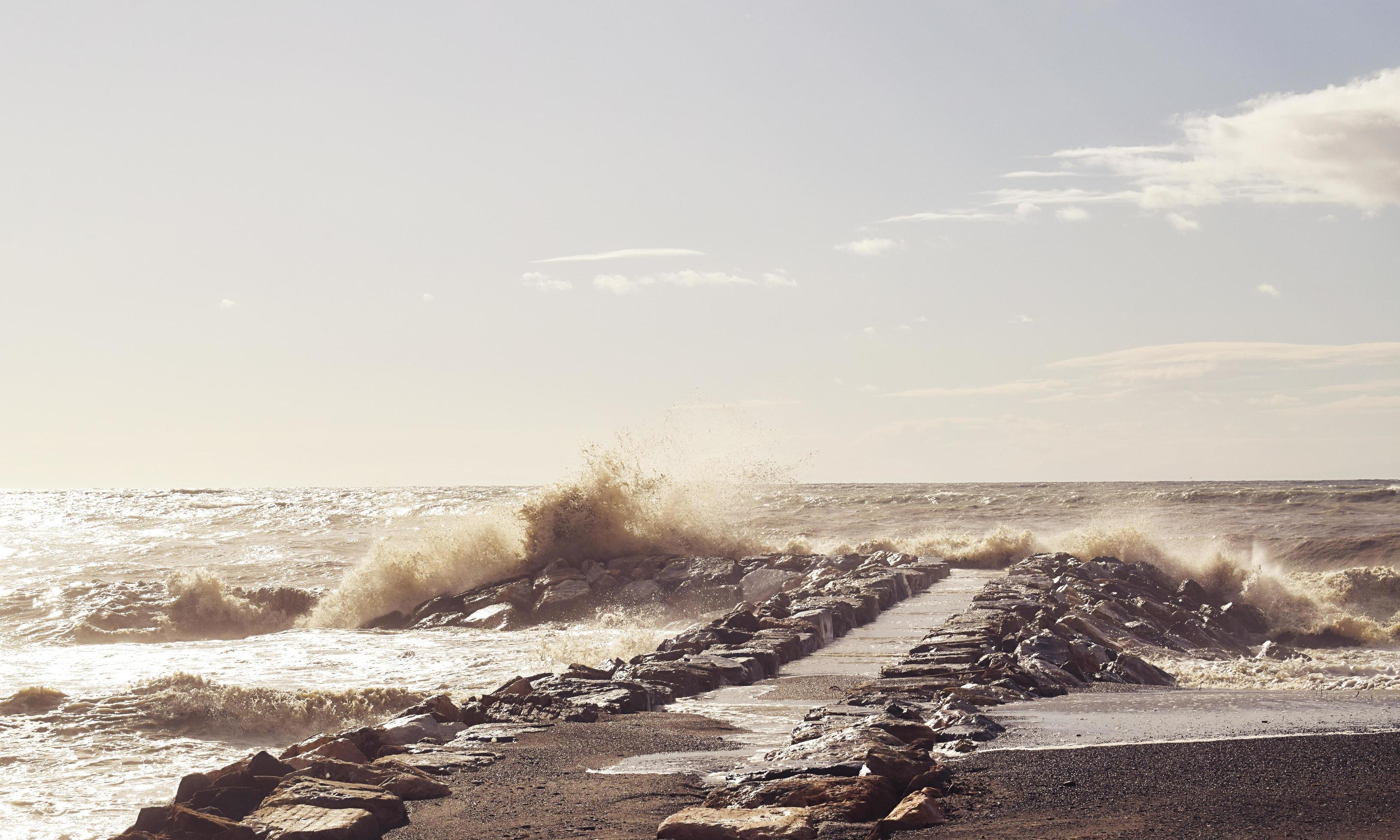 Waves crashing on ocean jetty 1418189 Stock Photo at Vecteezy