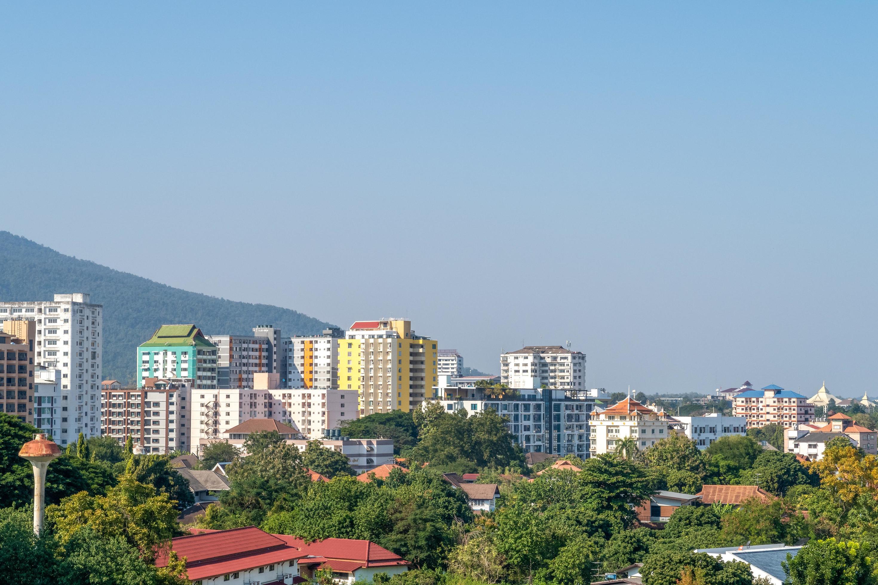 Landscape view of buildings and foliage on a blue sky background ...