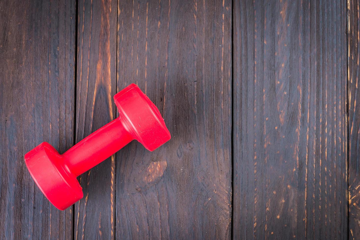 Dumbbell on wood background 2269255 Stock Photo at Vecteezy