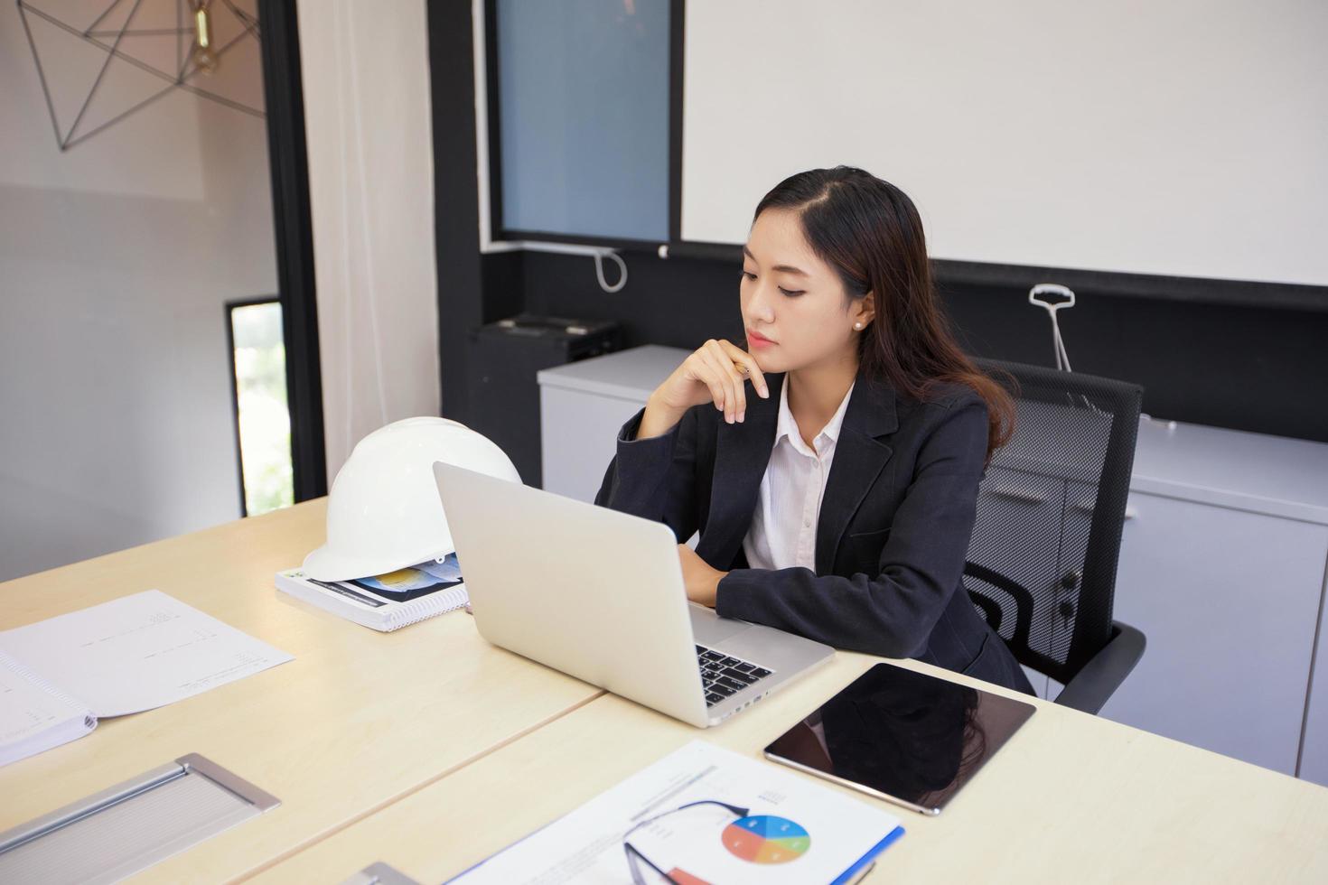 Business woman thinking in her office 2411594 Stock Photo at Vecteezy