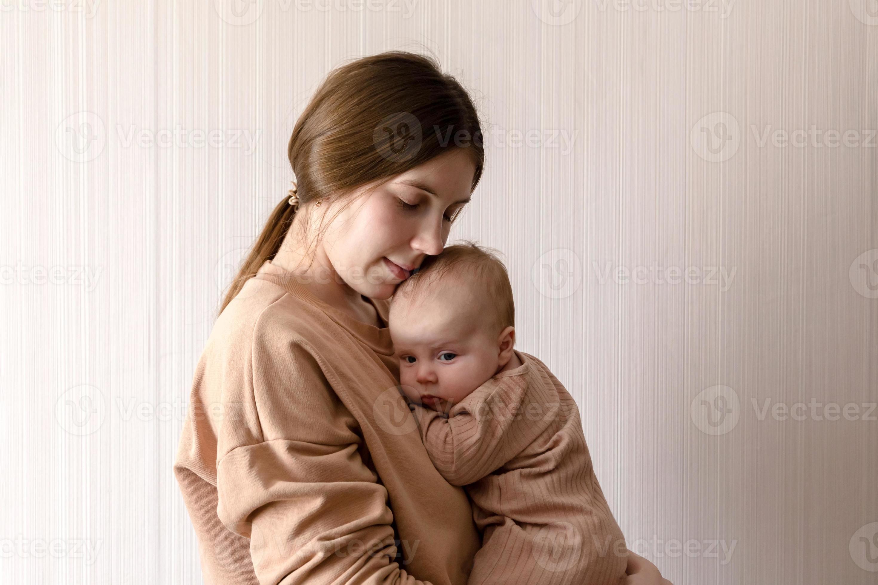 Cheerful beautiful young woman holding baby girl in her hands 2429685 ... Cheerful beautiful young woman holding baby girl in her hands 2429685 ...