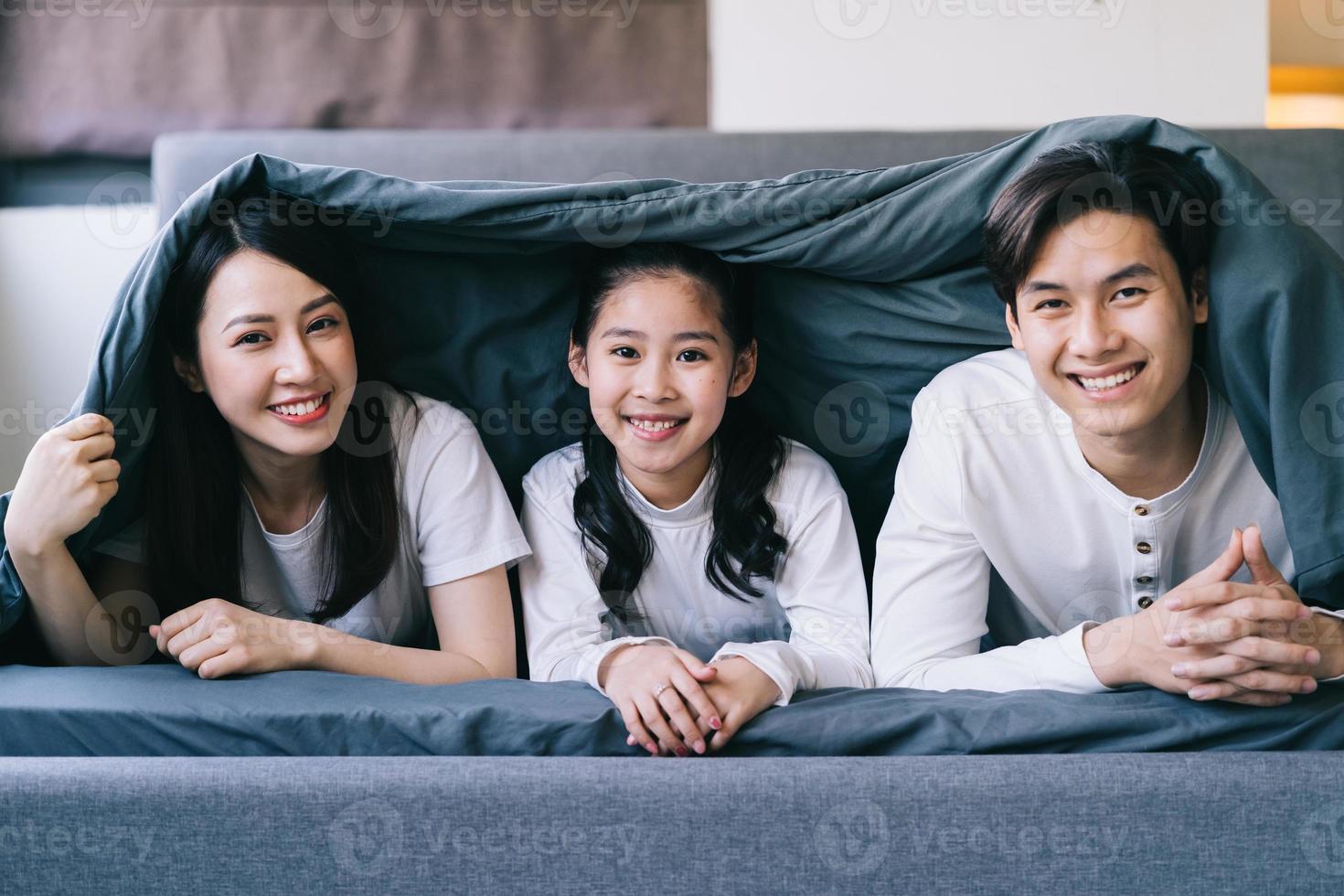 Happy Asian family portrait with mother, father and daughter 2877943 Stock Photo at Vecteezy