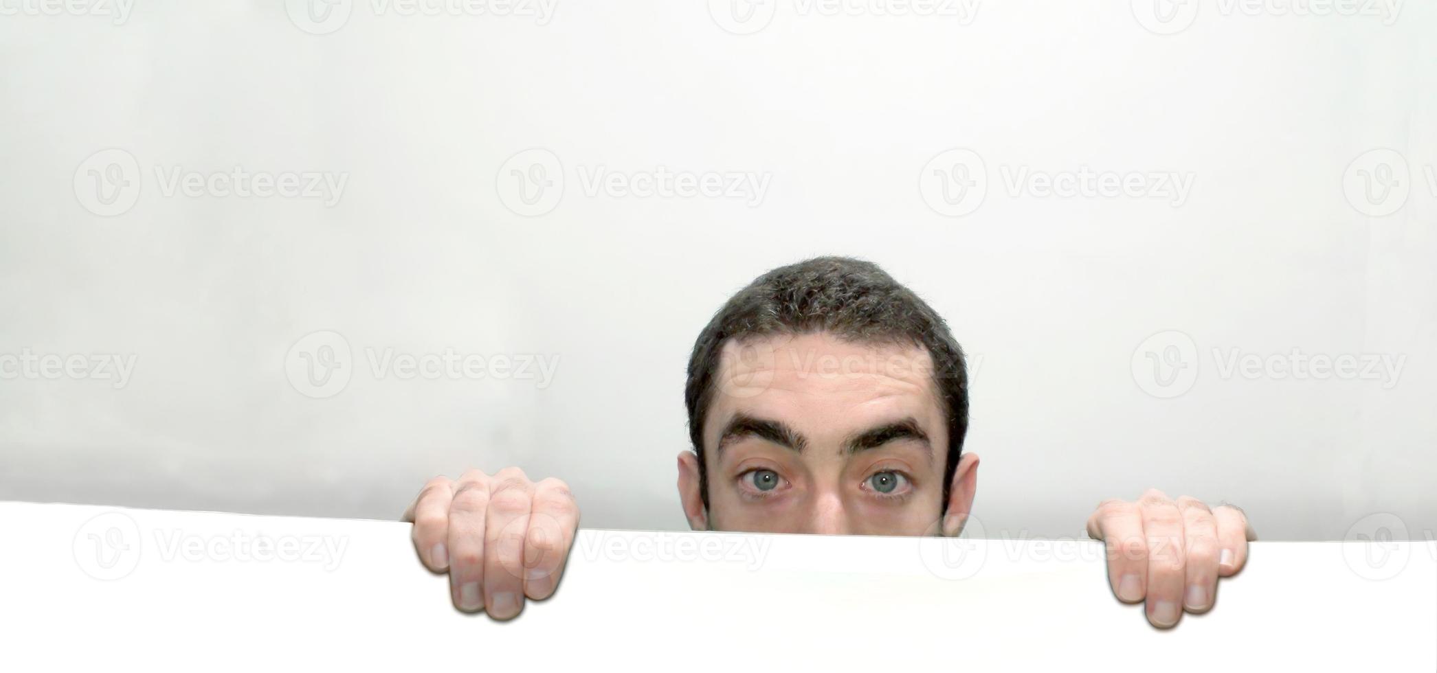 Man peeking behind a white wall 3069507 Stock Photo at Vecteezy