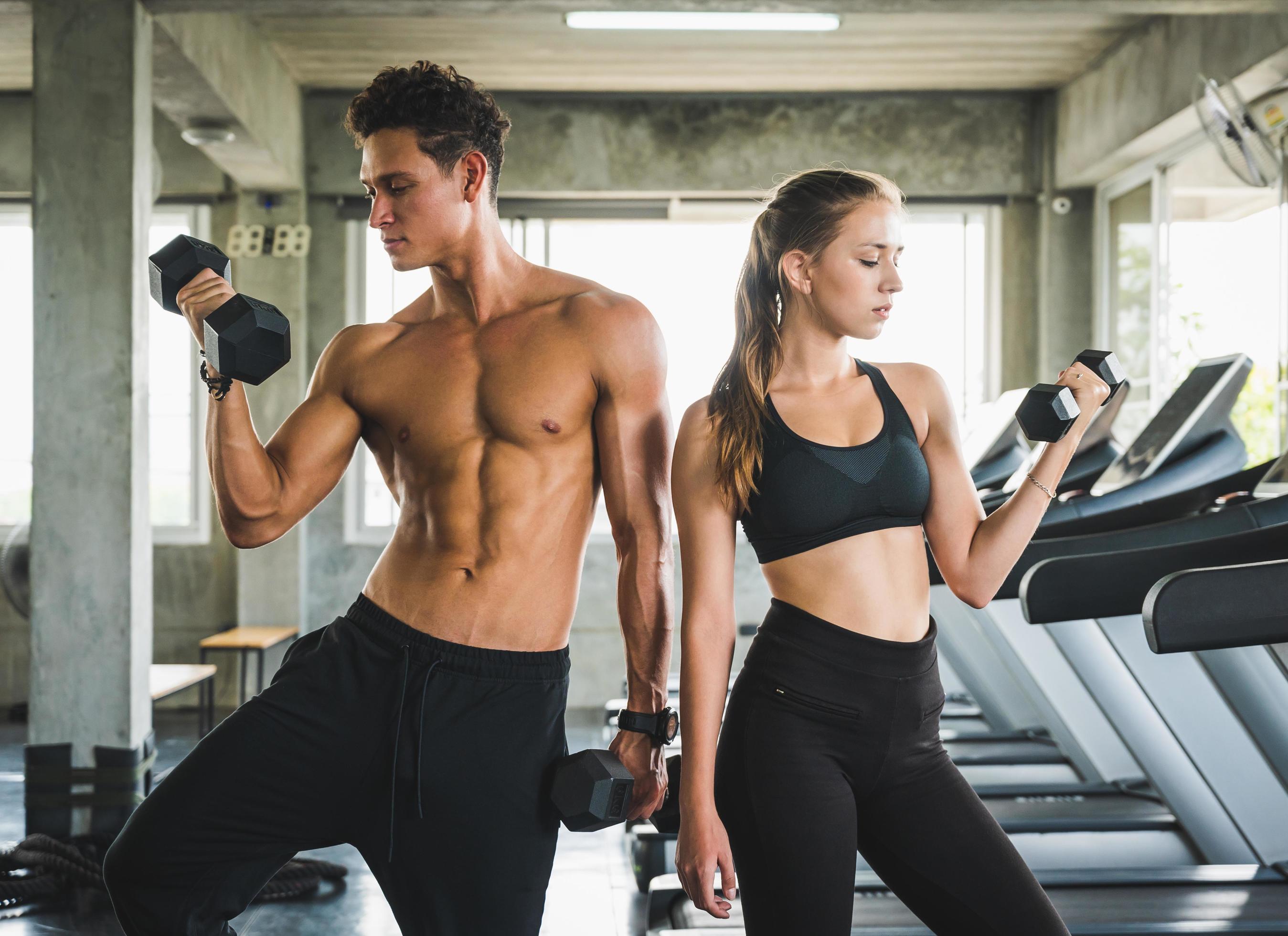 Fitness Man And Woman Holding Dumbbell Standing Posing Near Treadmill Muscular Couple Training