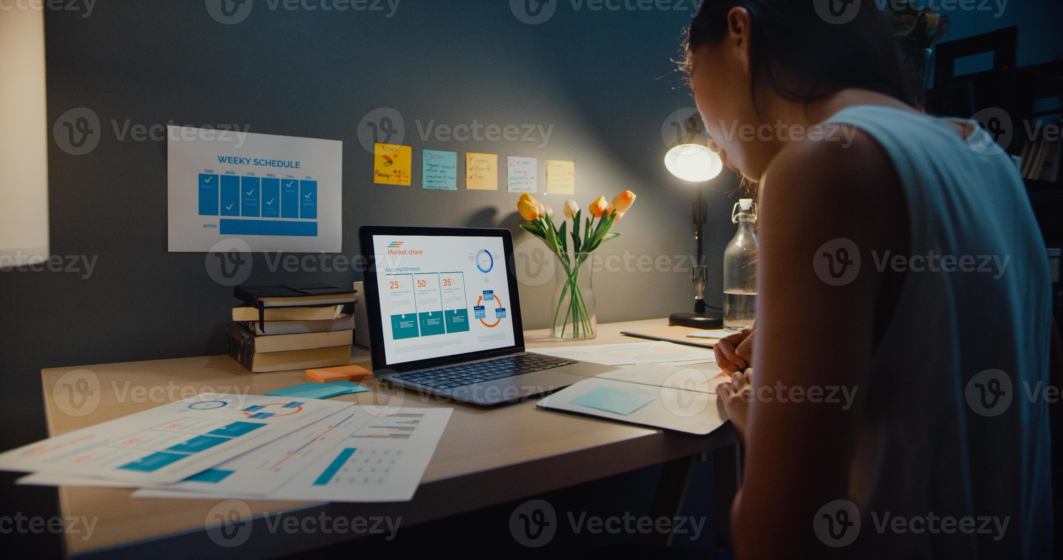 Young asia business lady freelance focus on laptop write worksheet ...