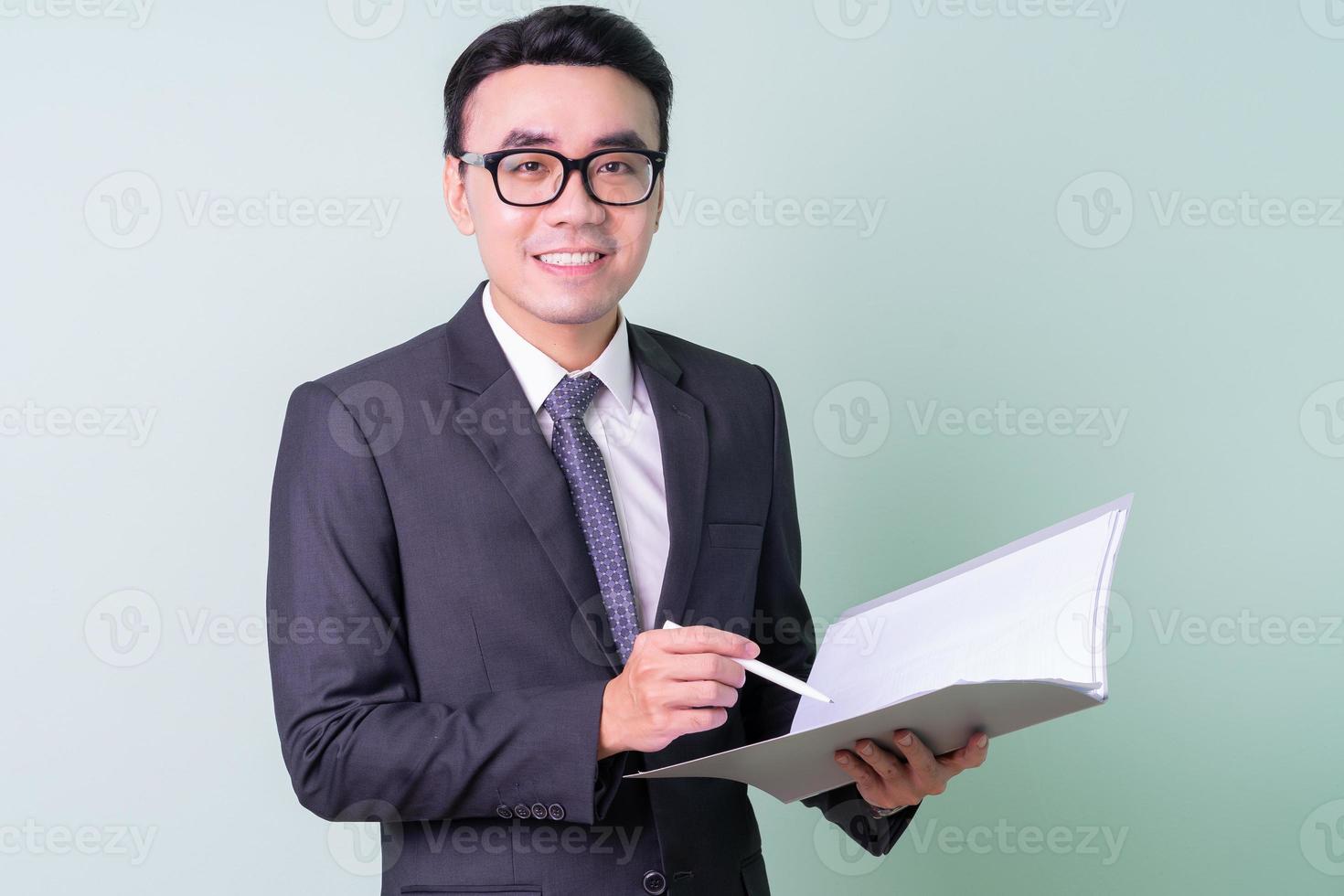Young Asian businessman posing on green background 3714567 Stock Photo ...