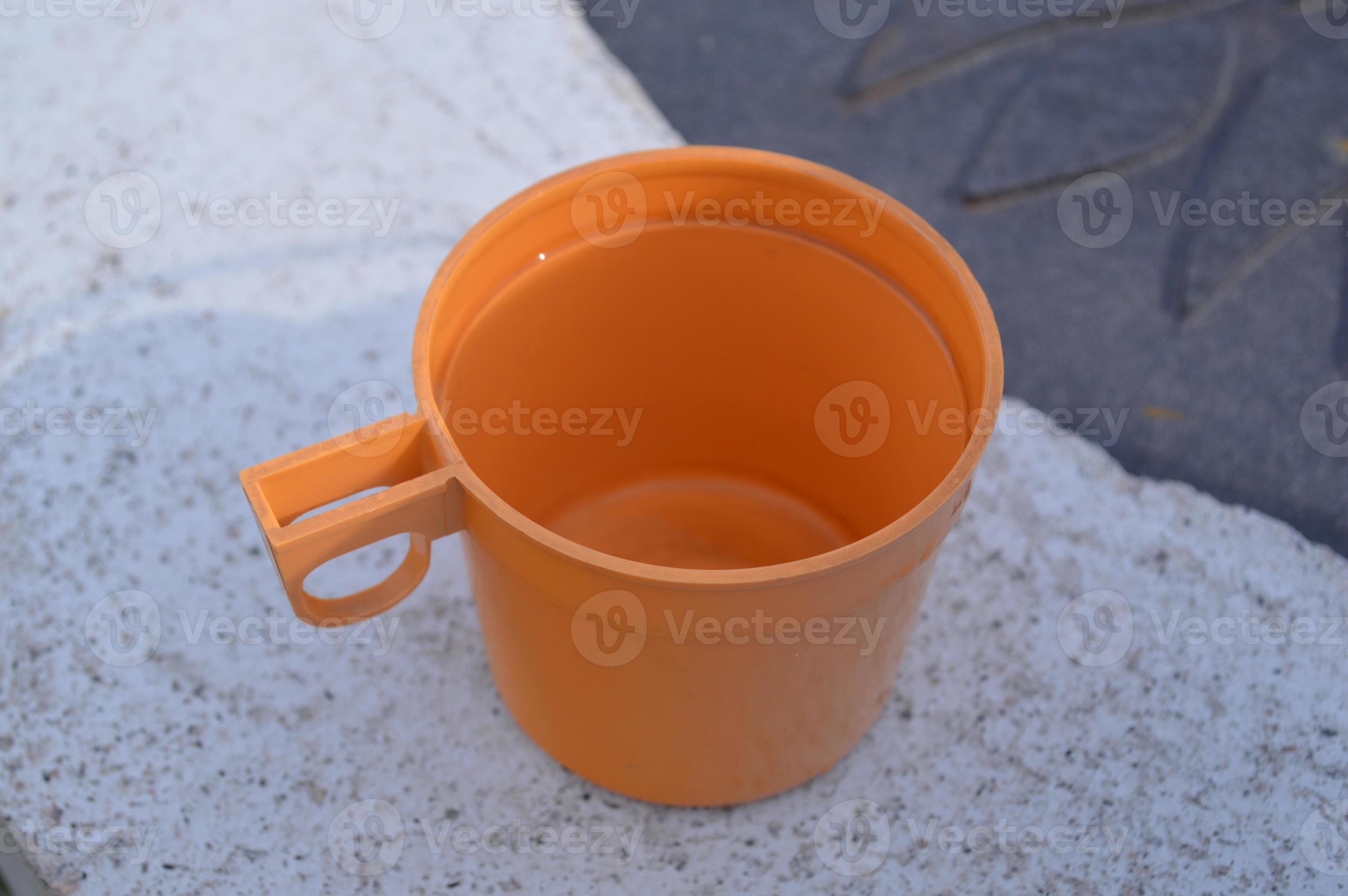 watering-plants-in-a-bucket-garden-with-water-from-a-well-3722299-stock