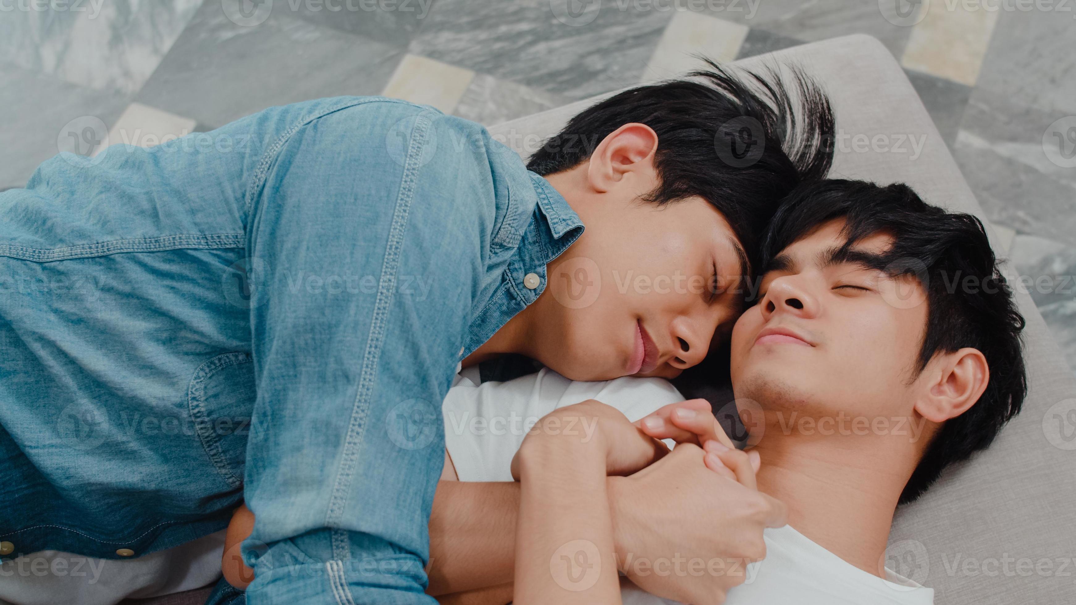 Young Asian gay couple sleep together at home. Teen korean LGBTQ men happy relax rest lying on ...