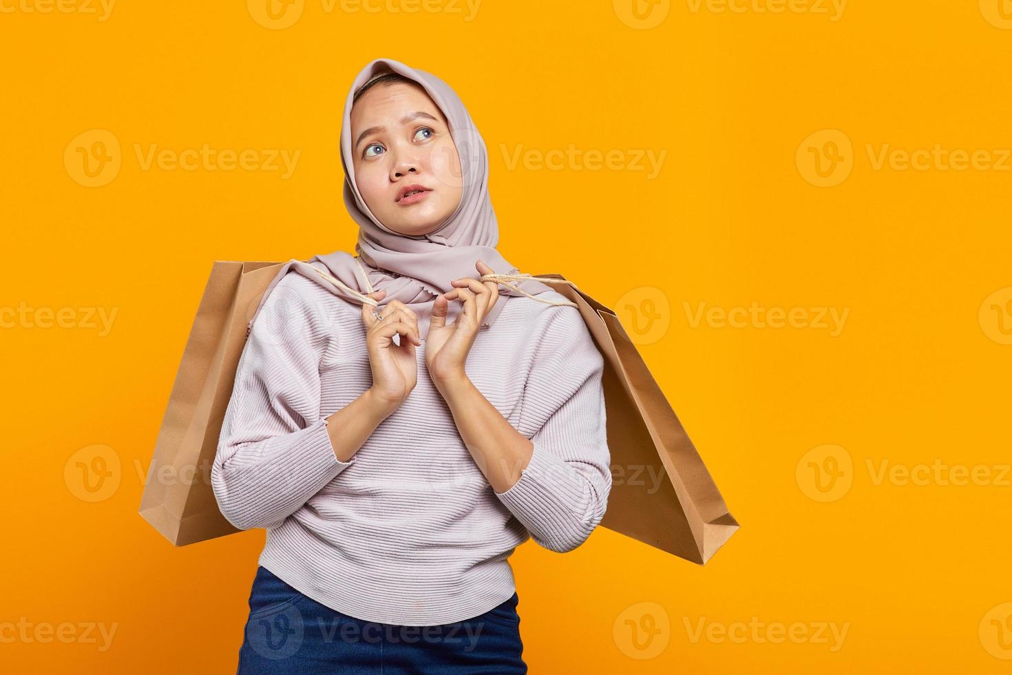 Portrait Of Beautiful Asian Woman Holding Shopping Bags And Looking