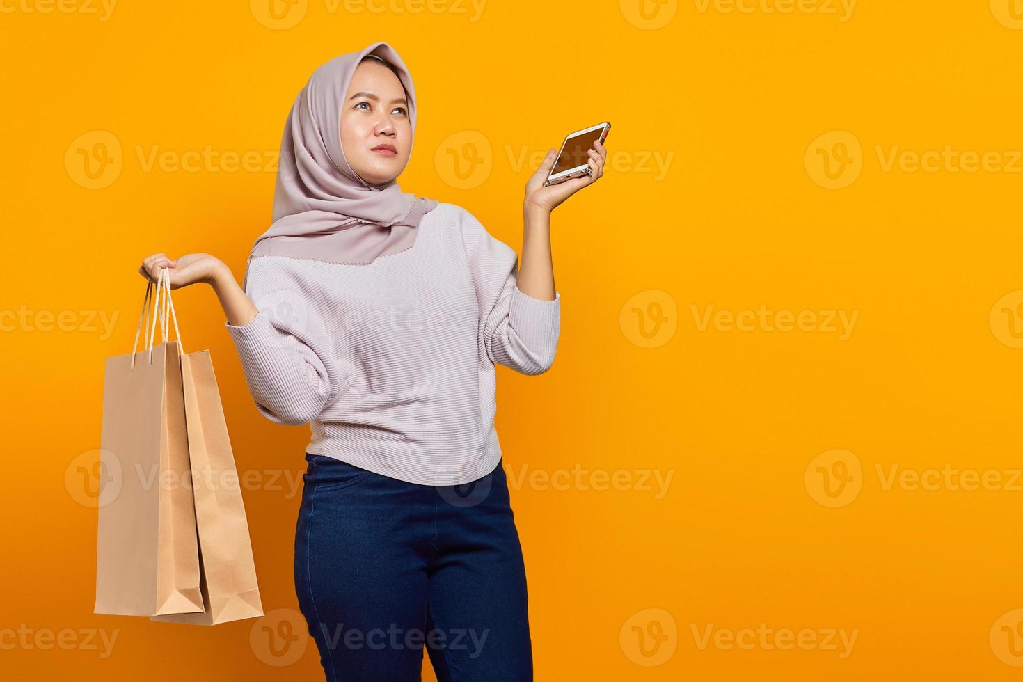 Portrait Of Beautiful Asian Woman Holding Shopping Bag And Smartphone