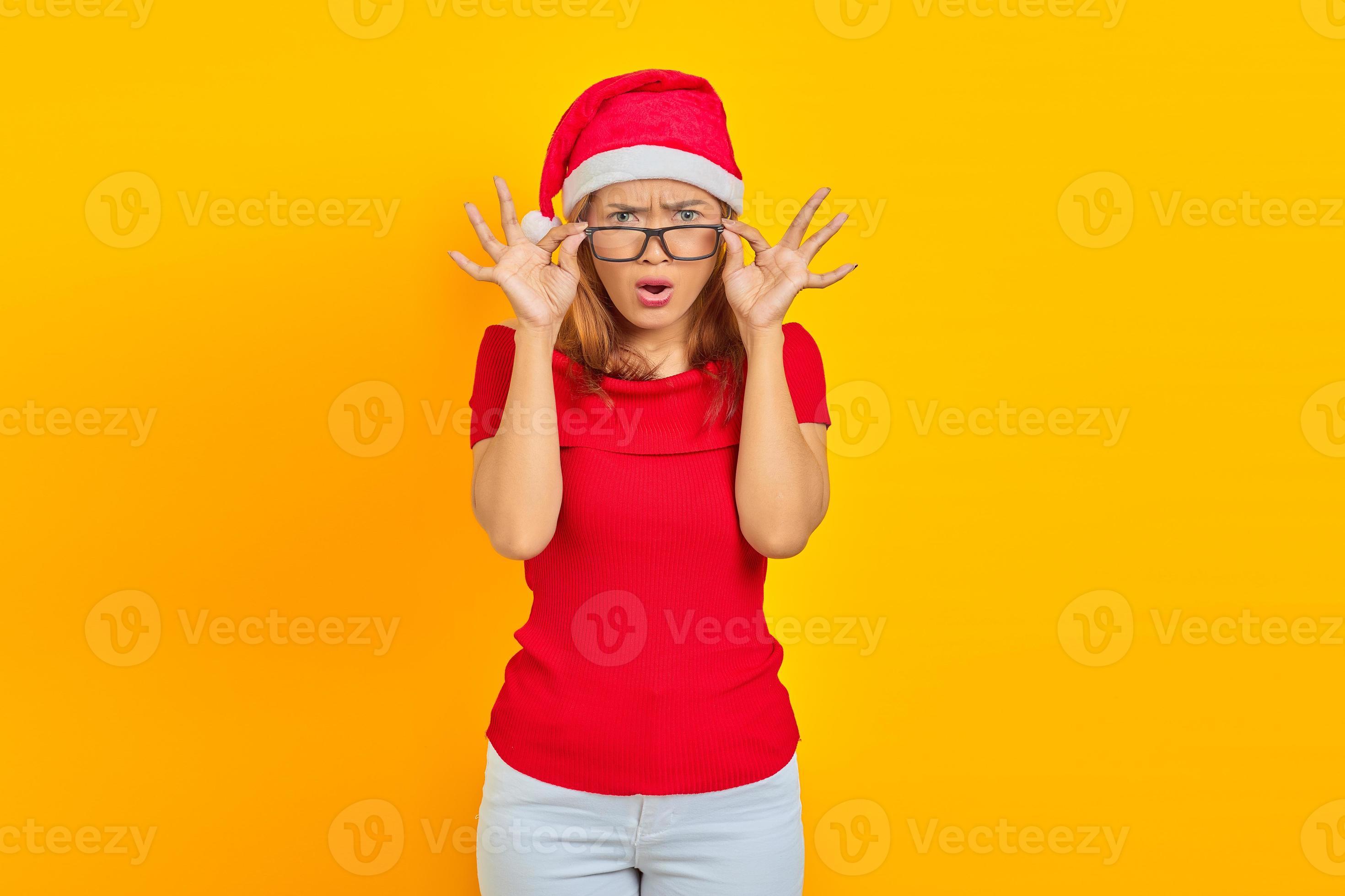 Surprised Young Asian Woman Wearing Christmas Hat With Glasses While