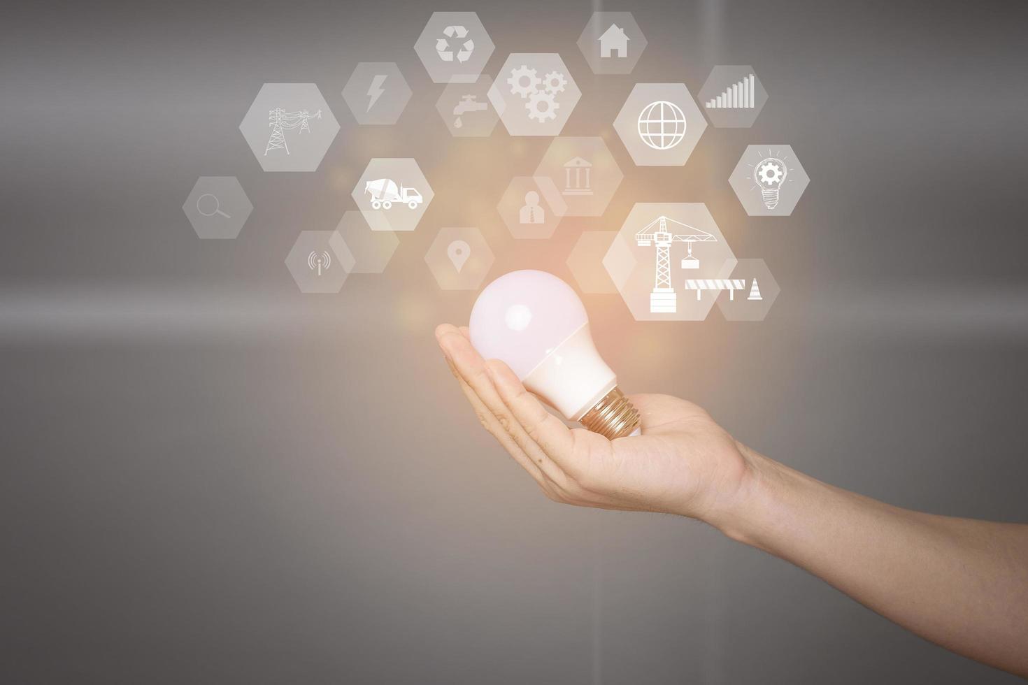 Close up human hand is holding Light bulb with engineering technology ...