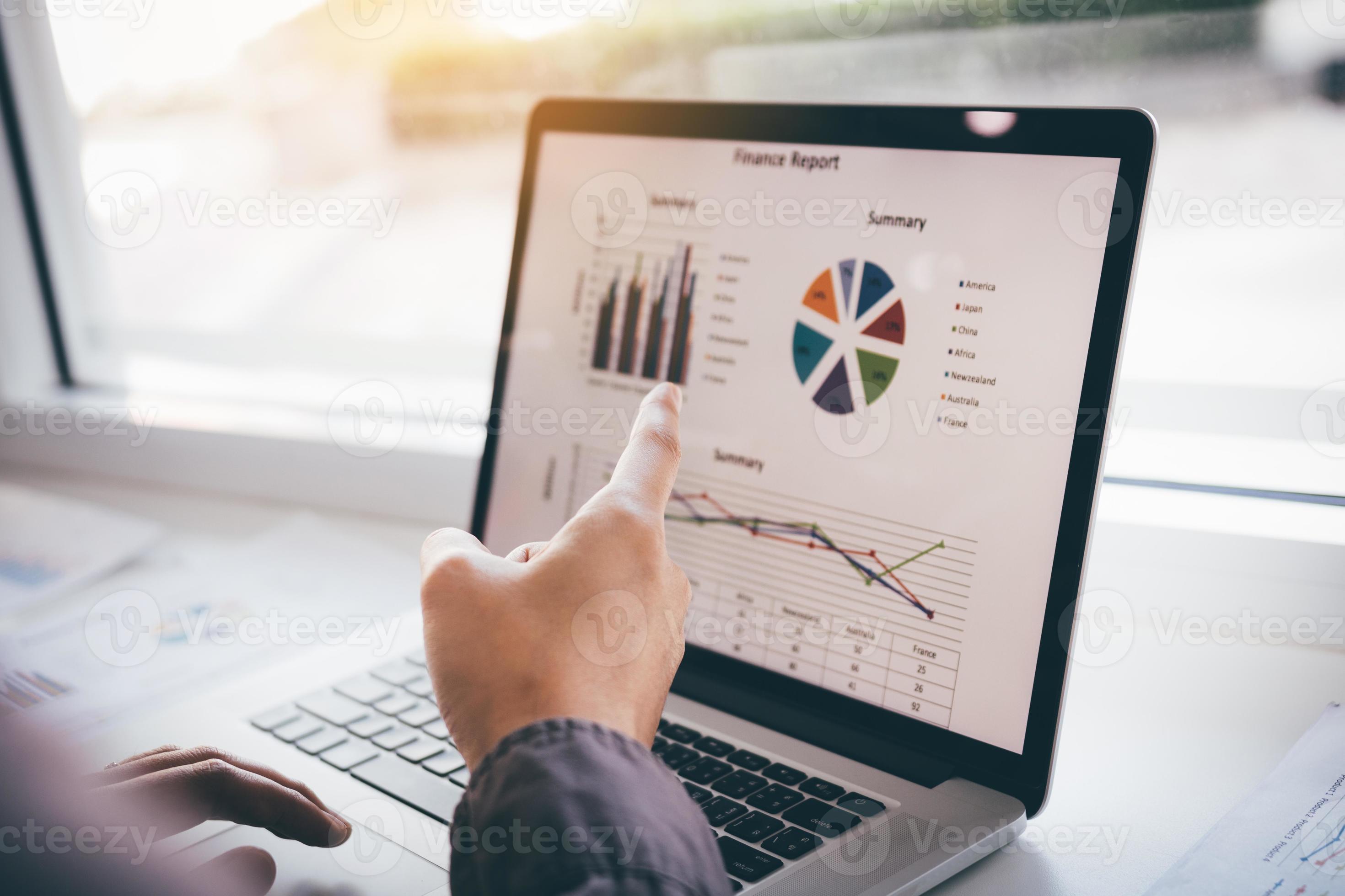 Investors man pointing laptop computers to analyze graphs in the ... Investors man pointing laptop computers to analyze graphs in the ...