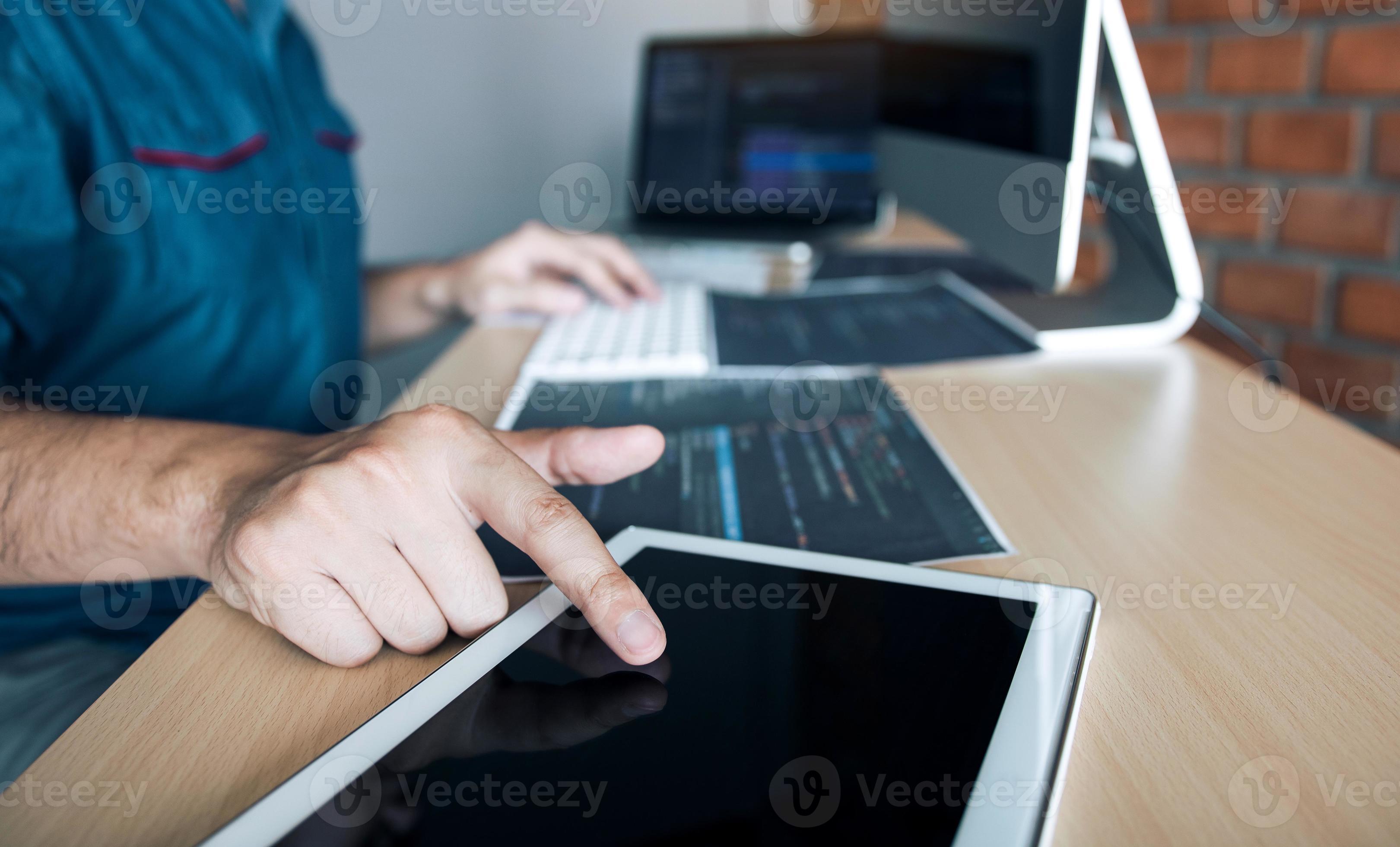 Software Developer Is Pointing To The Paper Working And Analyzing Together The Code Written Into