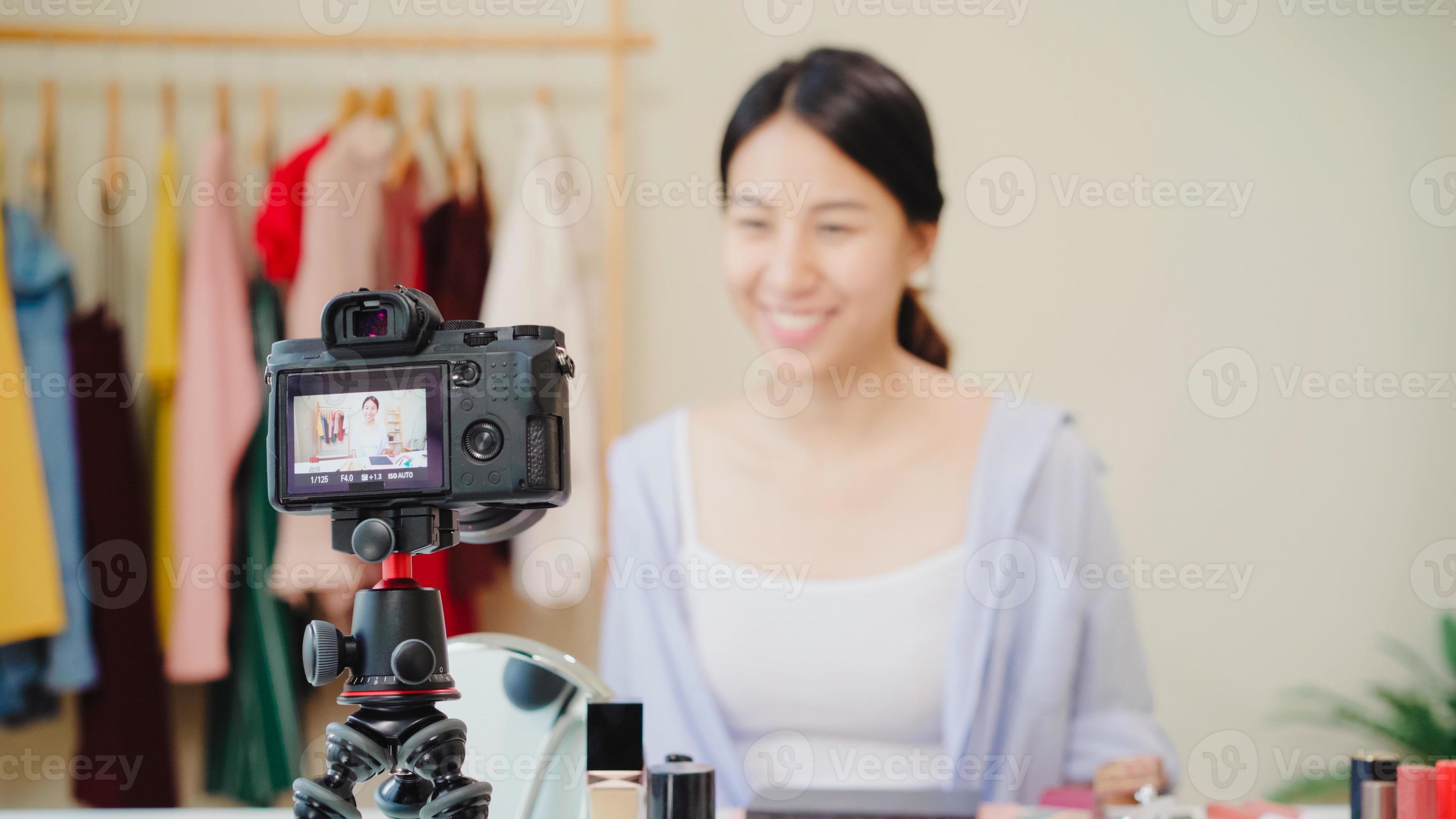 Beauty blogger present beauty cosmetics sitting in front camera for recording video. Beautiful ...