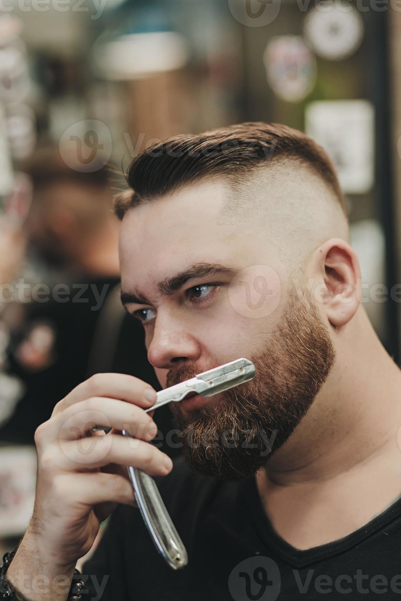 bearded brutal man with a straight razor 5967163 Stock Photo at Vecteezy