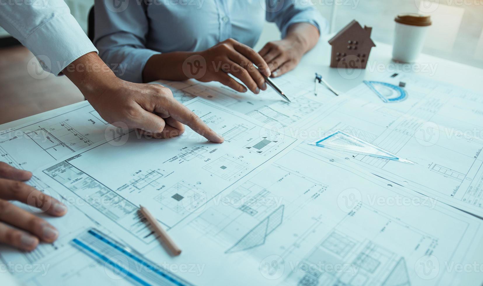 Architects engineer working with blueprints on table and discussing ...