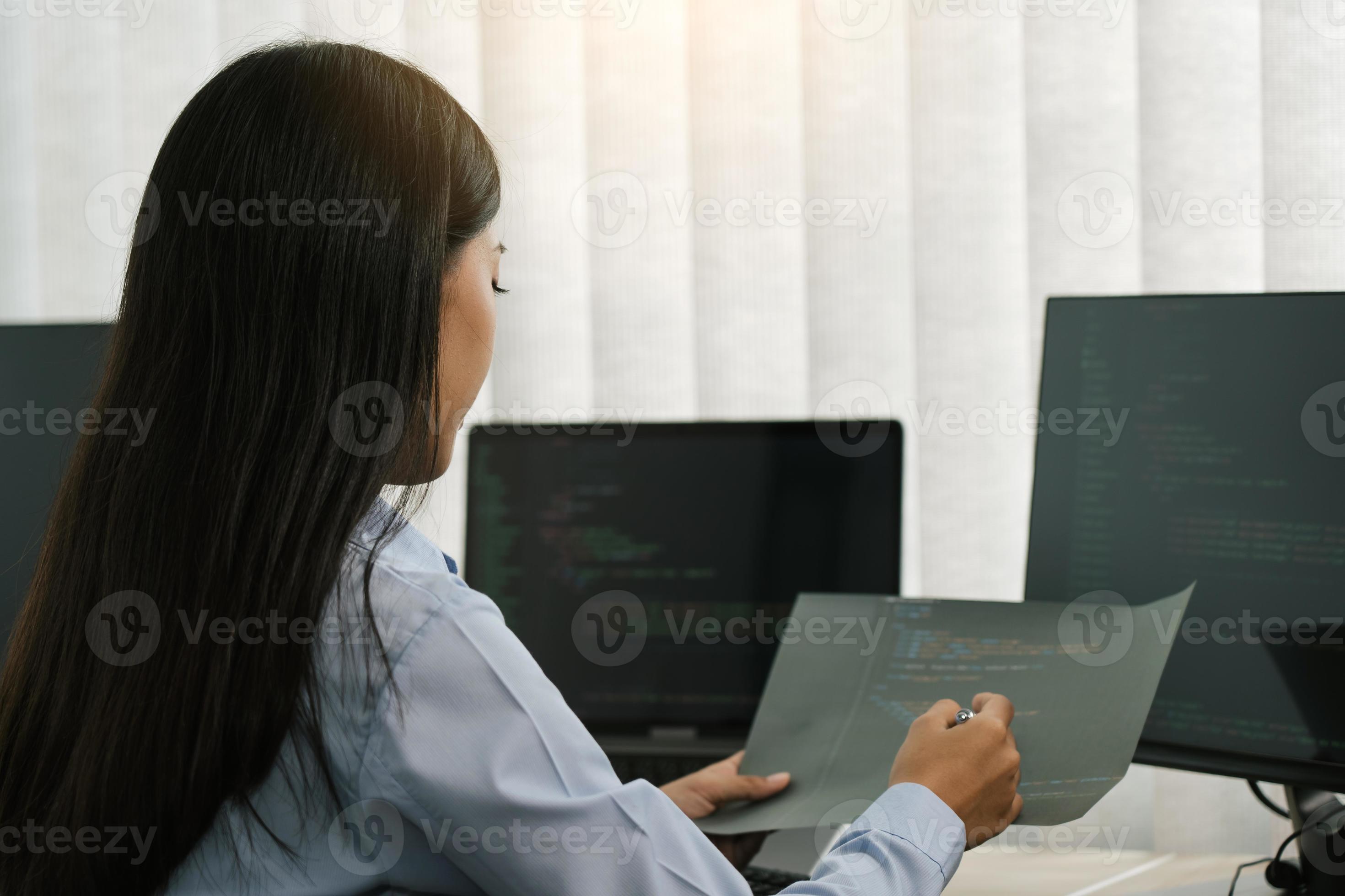 Asian Woman Software Developers Sitting In Front Of Computers Looking At Computer Codes On The