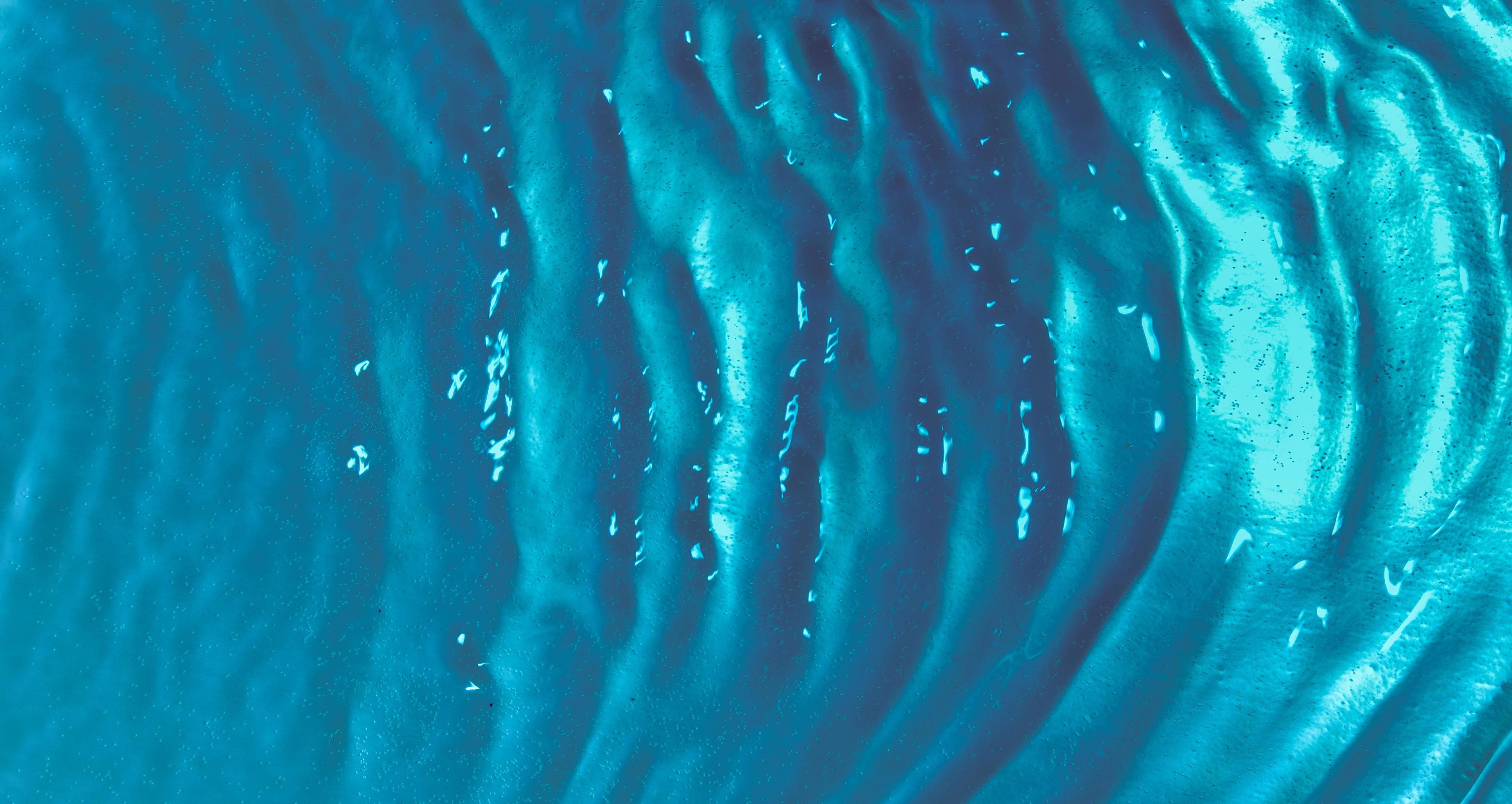 Water waves top view with bubbles on a turquoise background. Water ...