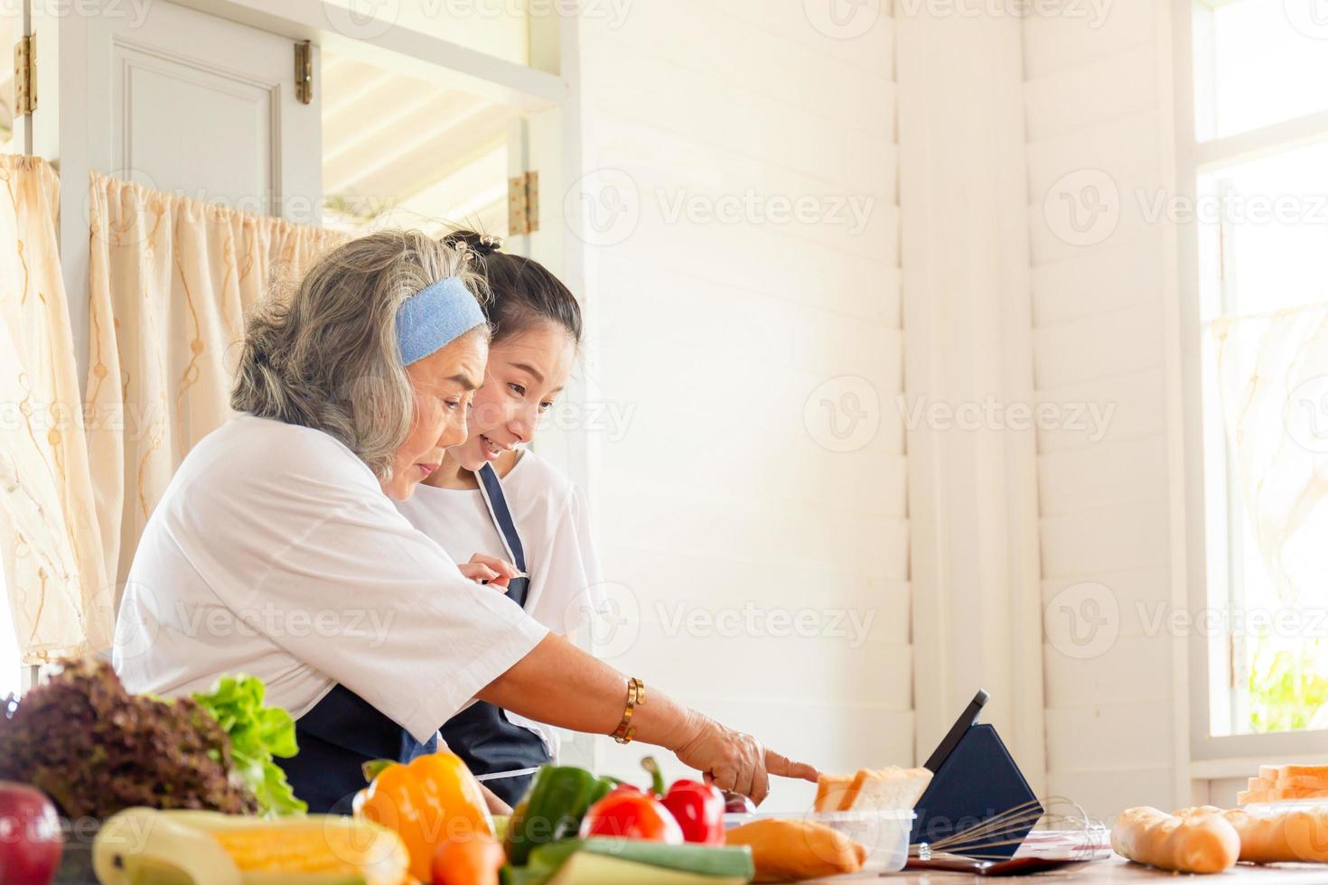 Senior asian mother and middle aged daughter cooking together at kitchen 6774643 Stock Photo at ...