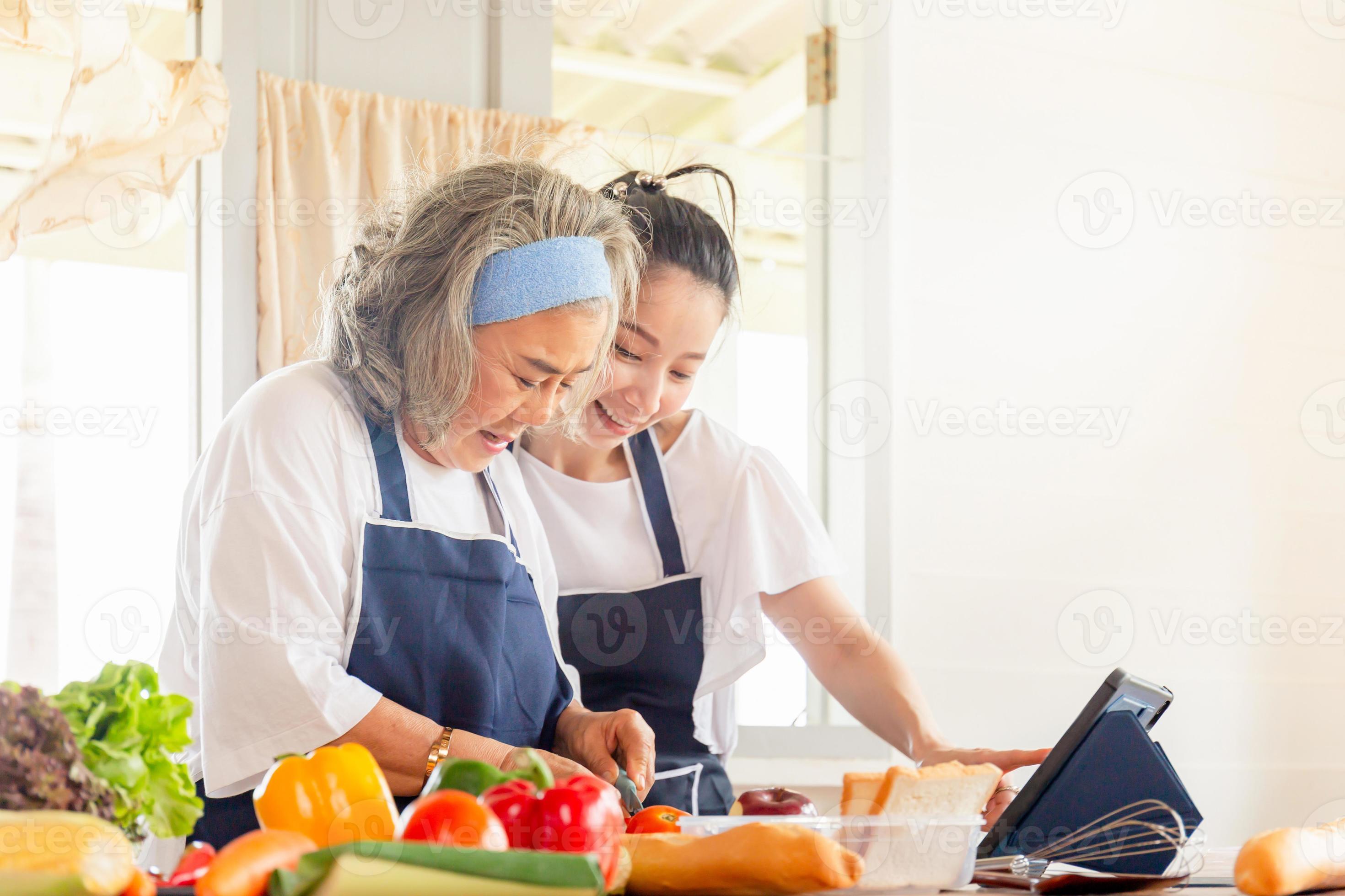 Senior asian mother and middle aged daughter cooking together at kitchen 6774646 Stock Photo at ...
