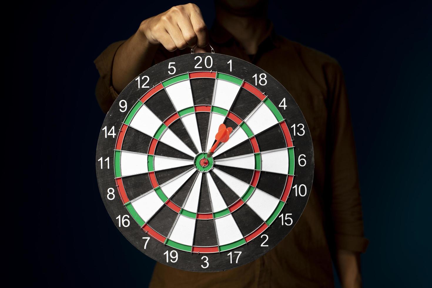 young man holding dart on dark background 6792545 Stock Photo at Vecteezy young man holding dart on dark background 6792545 Stock Photo at Vecteezy