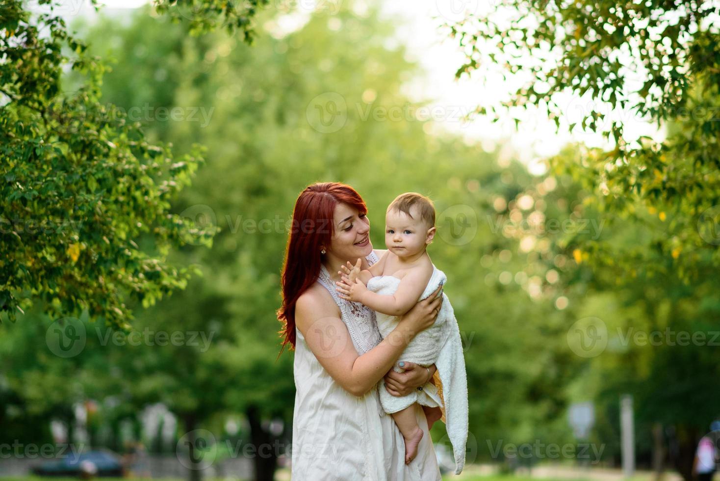 Mom Hugs And Plays With Her One Year Old Daughter Wrapped In A Towel