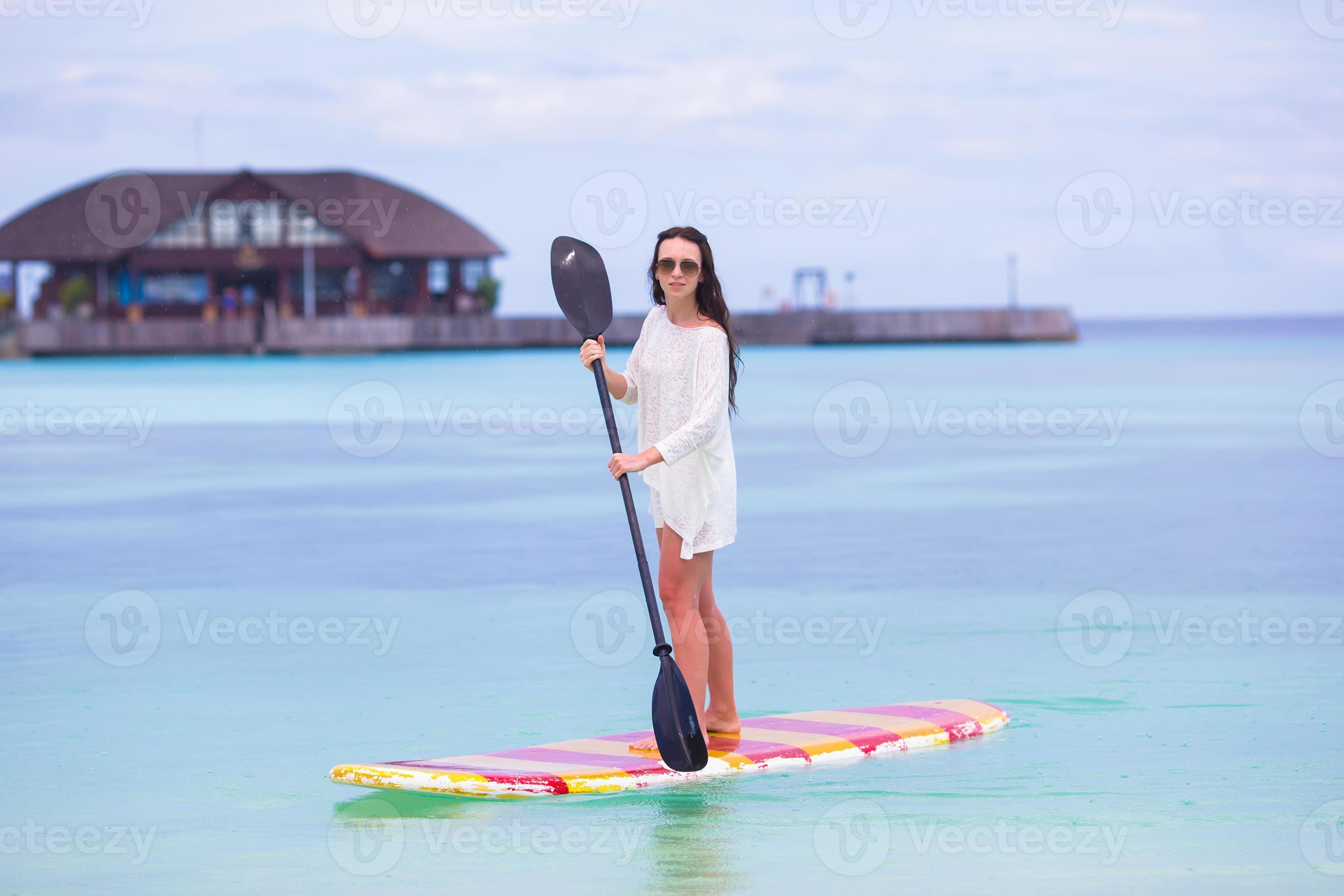 Active young woman on stand up paddle board 7294697 Stock Photo at Vecteezy