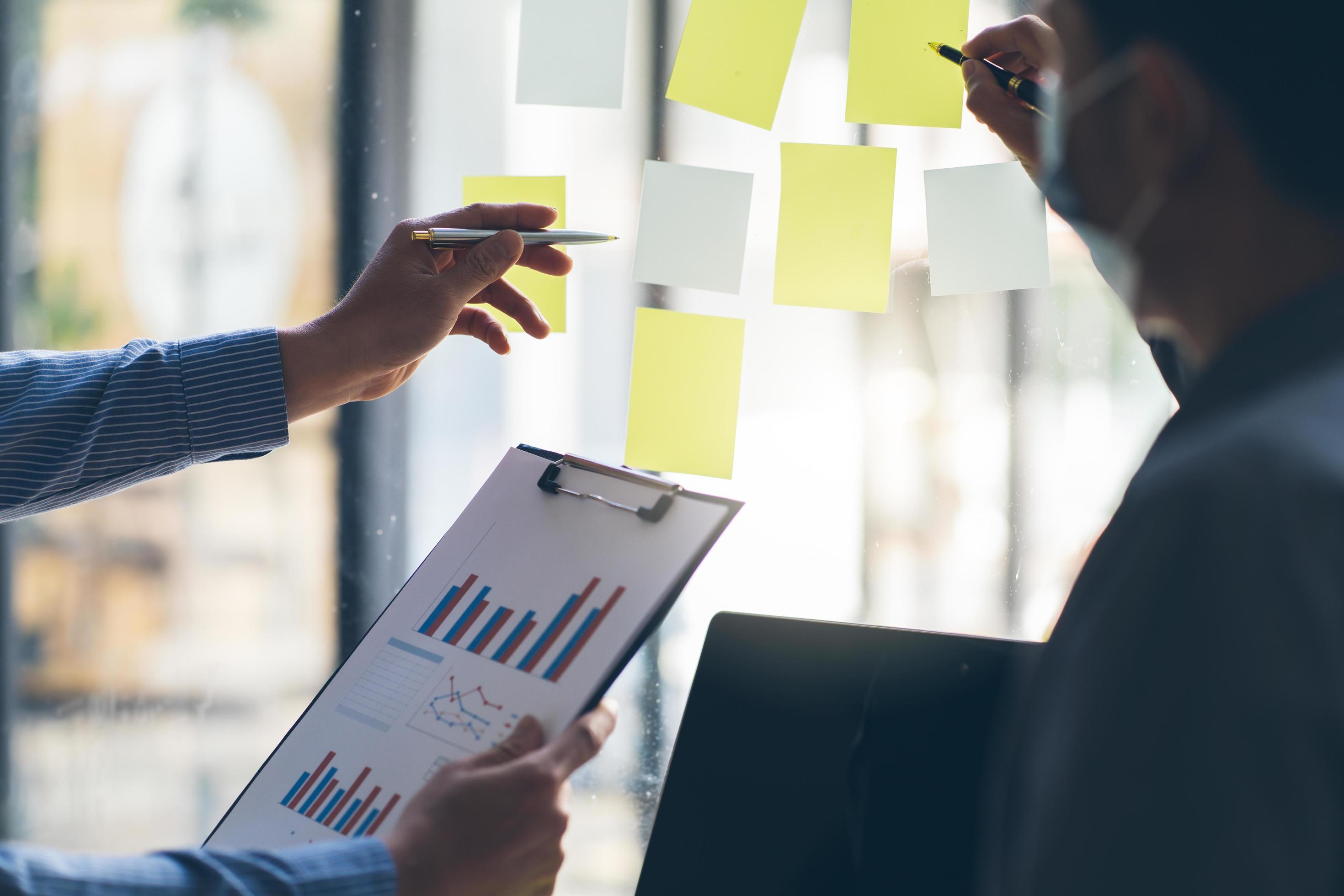 Business people meeting at office and use post it notes to share idea ...