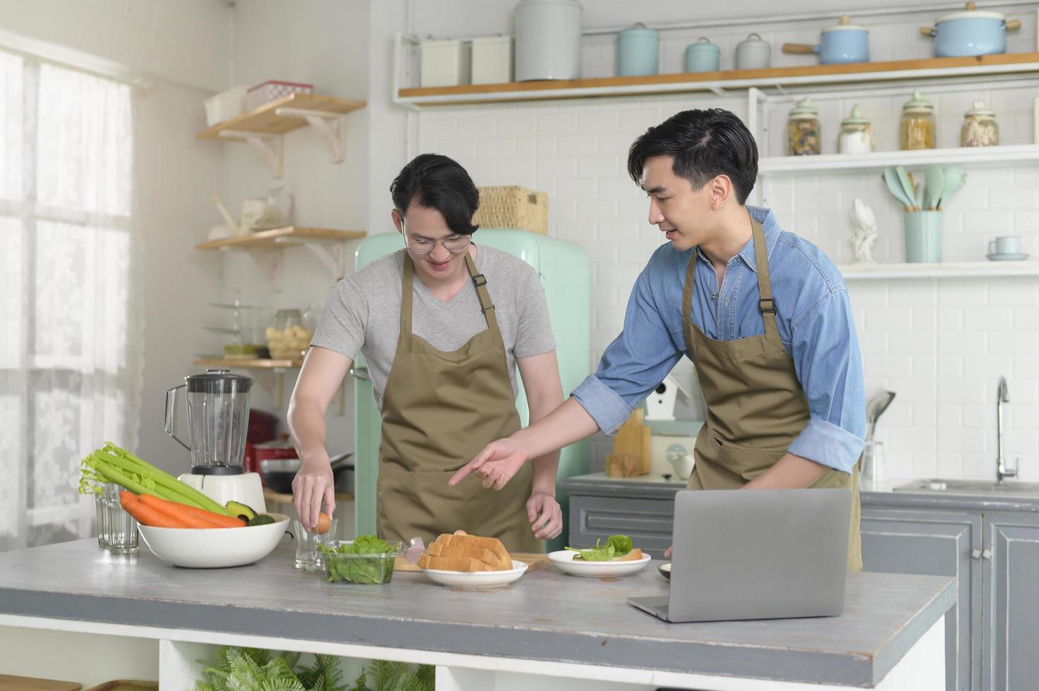 Young Smiling Gay Couple Cooking Together In The Kitchen At Home Lgbtq
