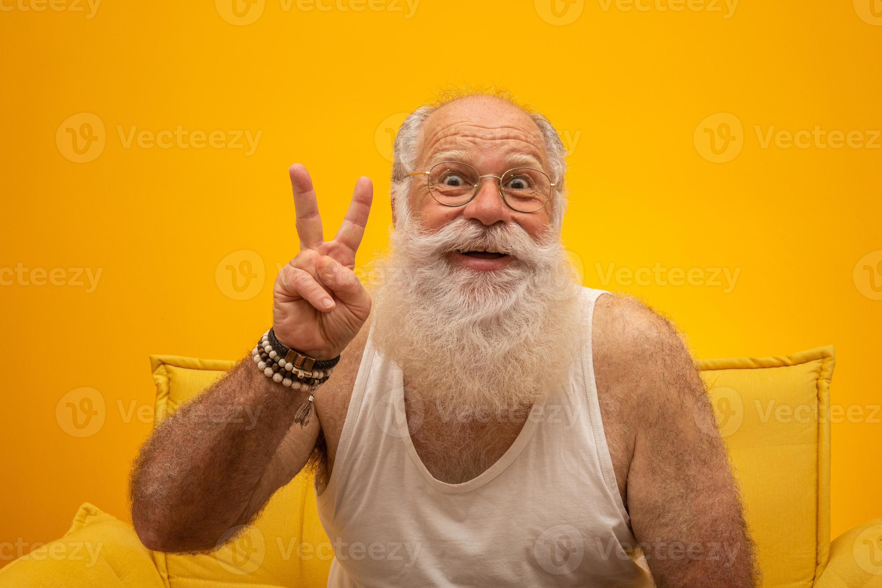 Smiling senior with a long white beard man making two times sign ...