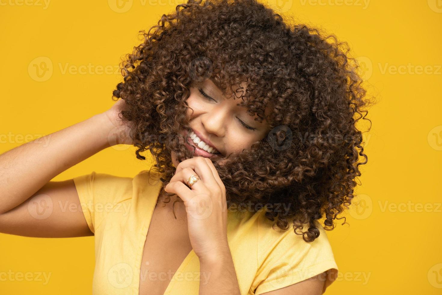 Happy Laughing American African Woman With Her Curly Hair On Yellow
