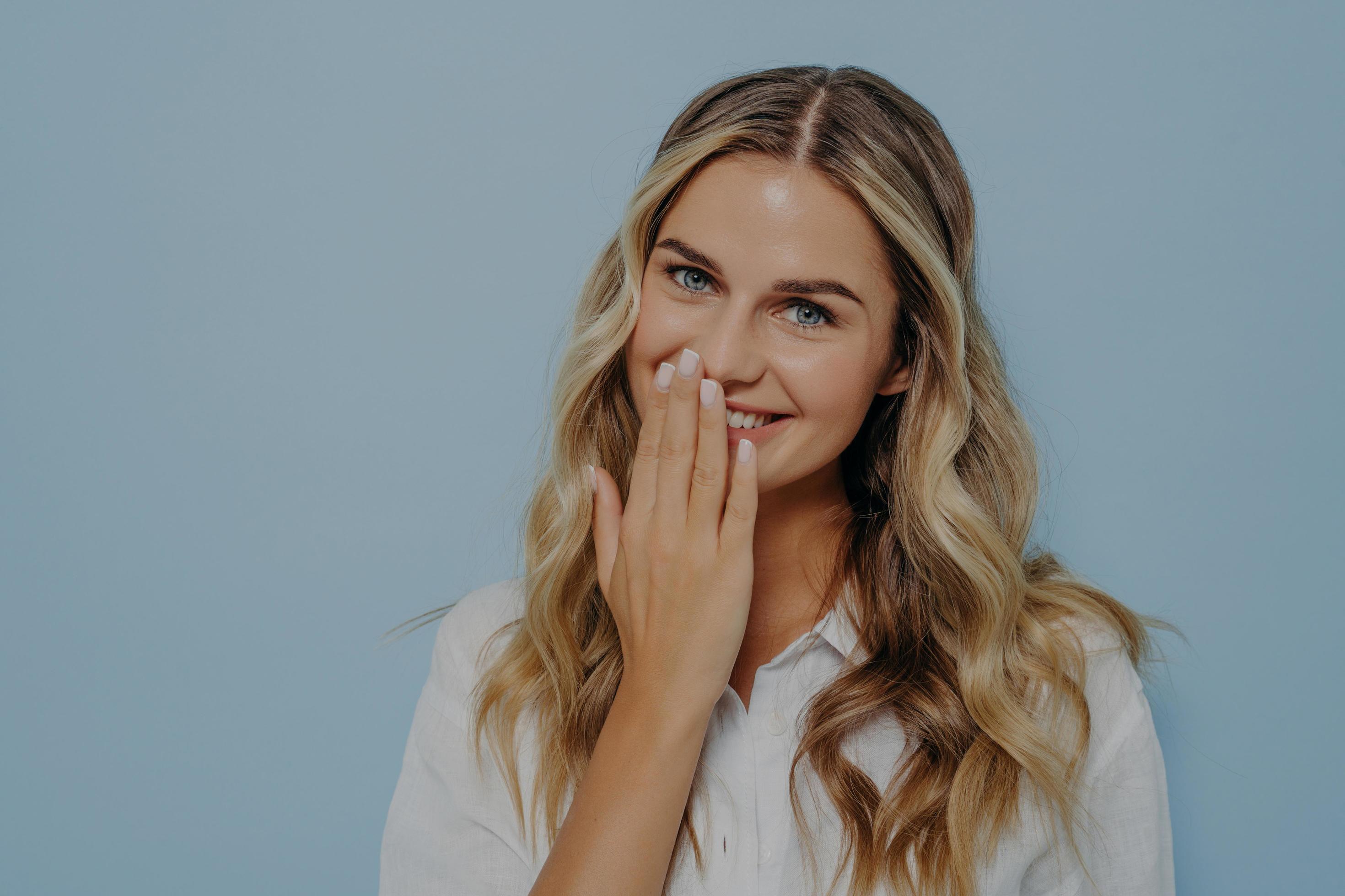 Blonde Woman Being Flattered Covering Her Mouth With Hand 7661903 Stock