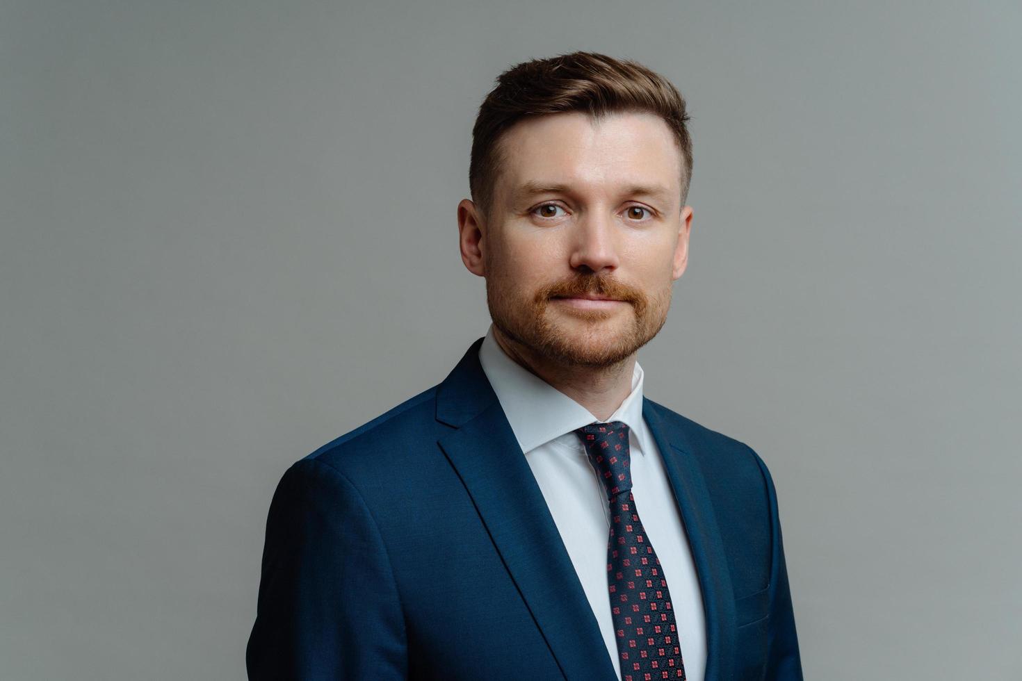 Handsome unshaven man in suit posing against grey background 7662995 ...