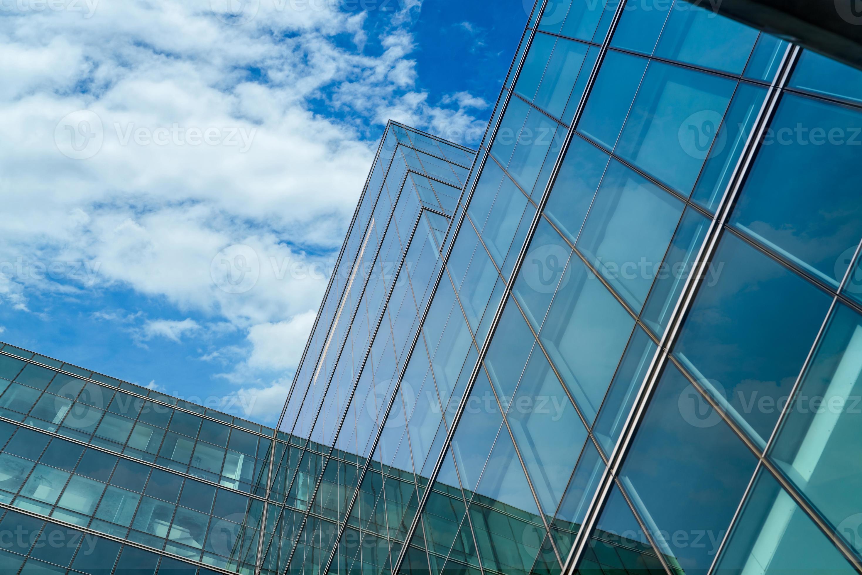 Low angle view of modern glass office building abstract background ...