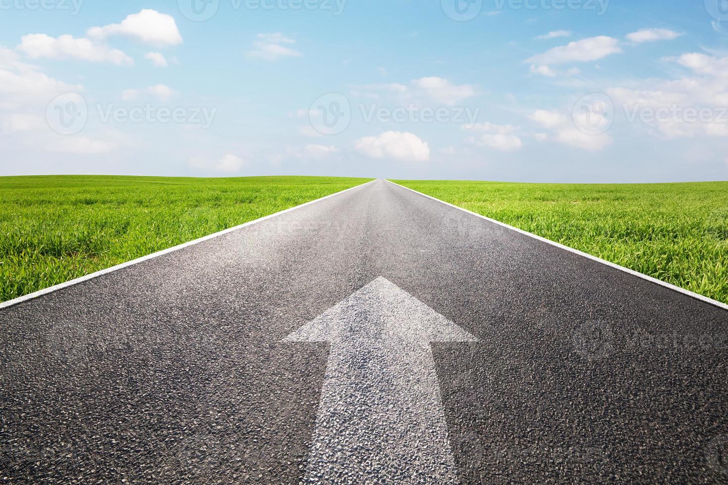Arrow sign pointing forward on long empty straight road, highway ... Arrow sign pointing forward on long empty straight road, highway ...