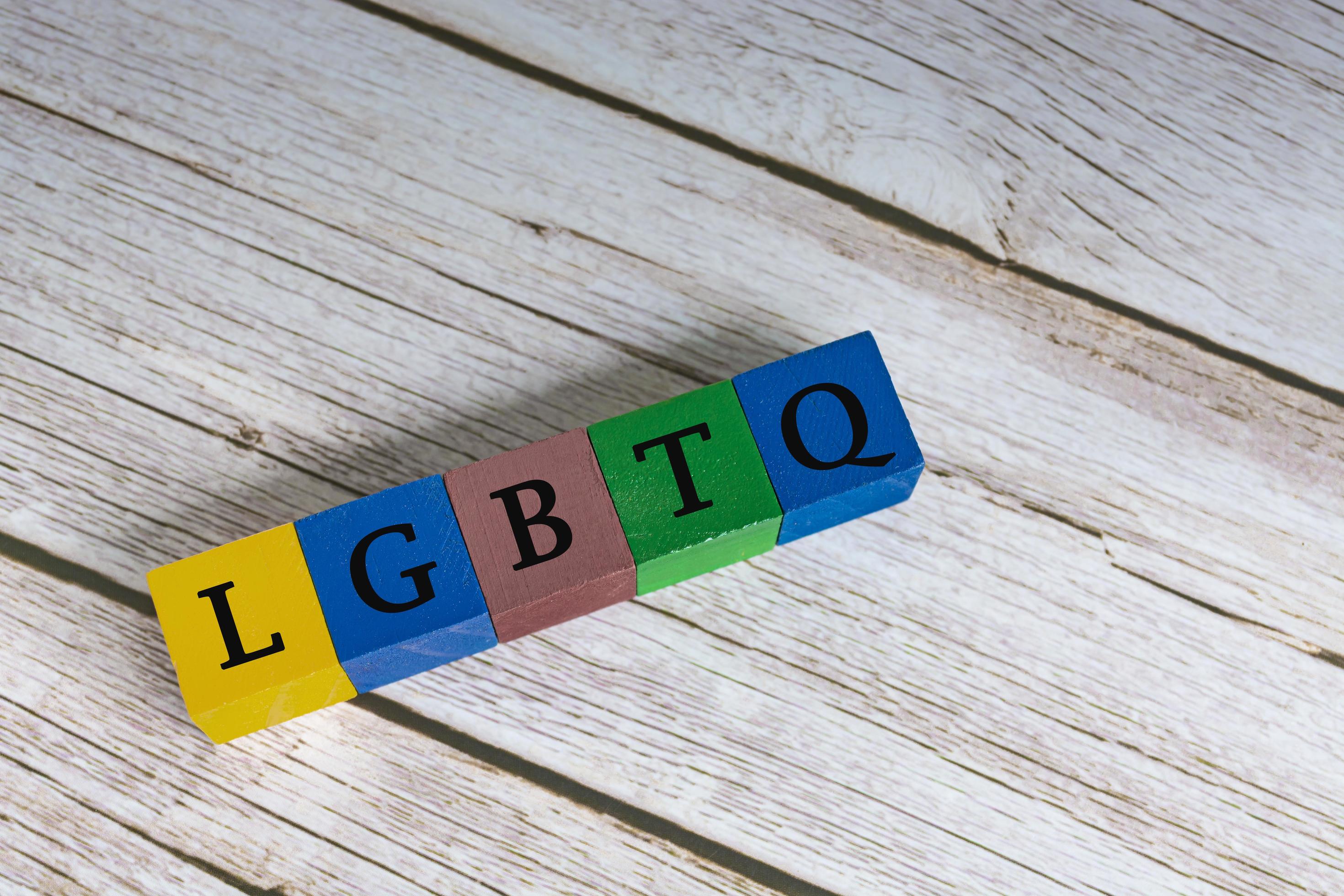 LGBTQ acronym on colorful wooden cubes against blue background. 7971368 ...