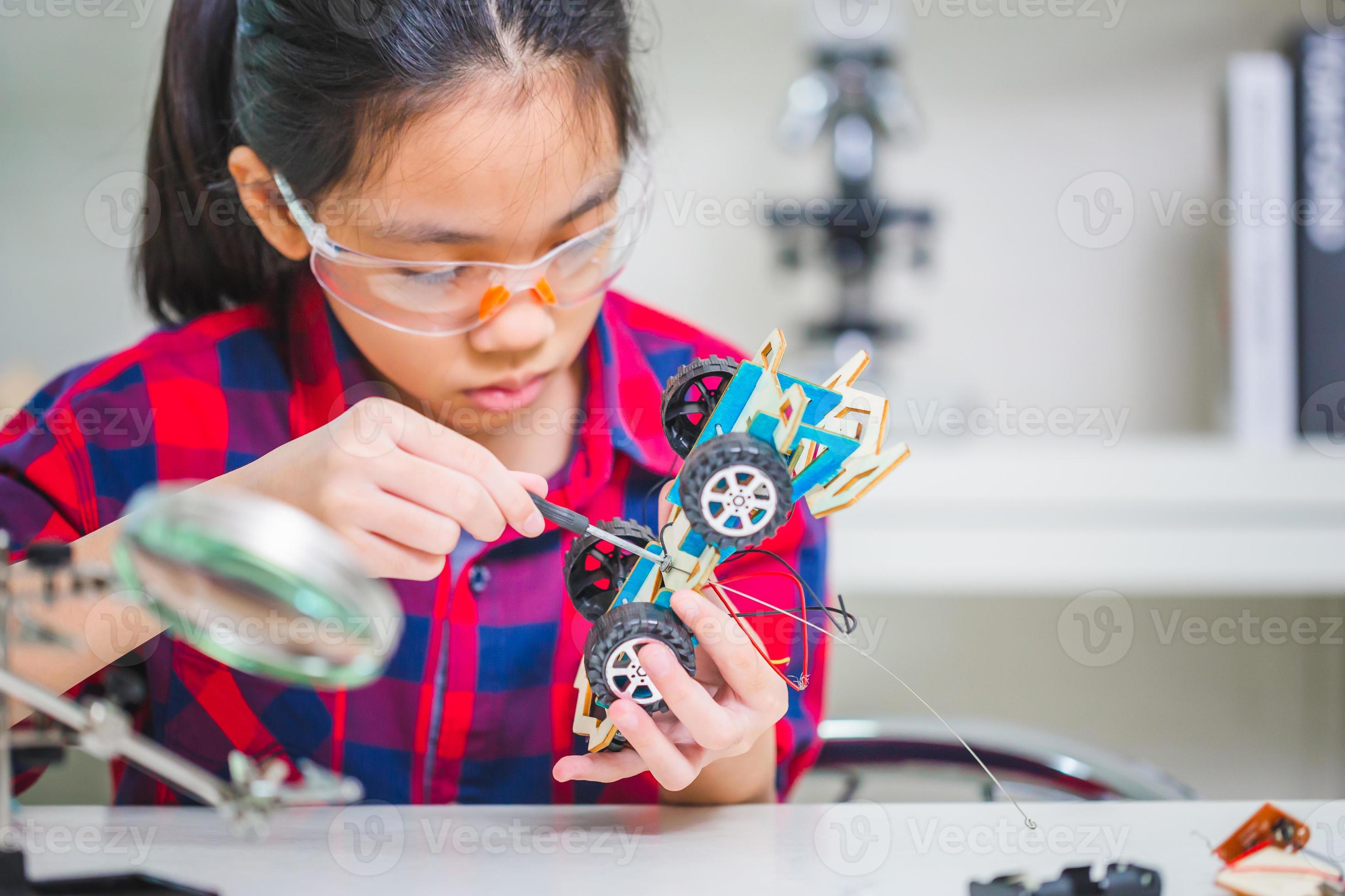 Close up of Child girl student build robotic cars, kid learning ...