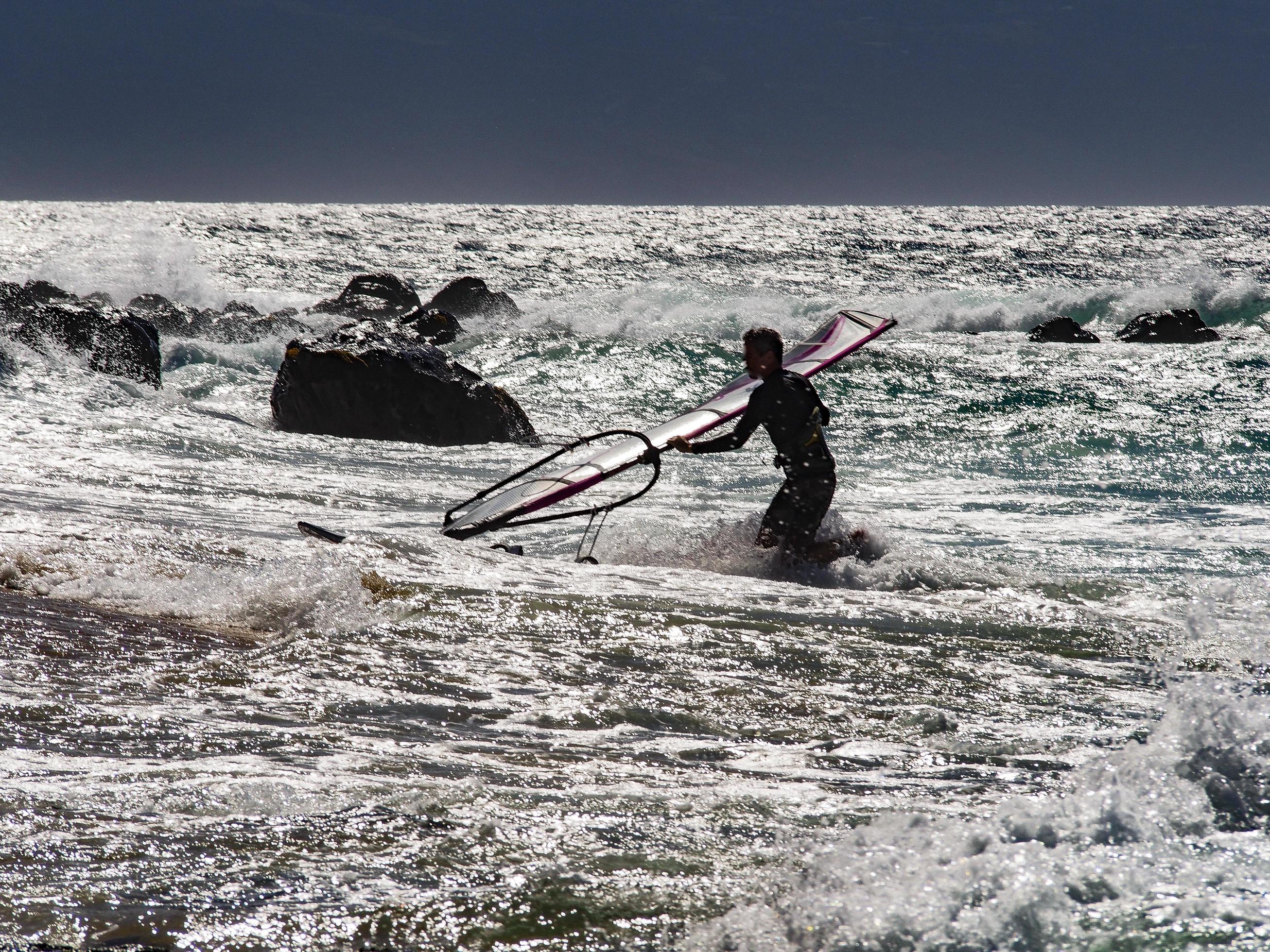 Surfer running in waves at shore. - bright 8052606 Stock Photo at Vecteezy