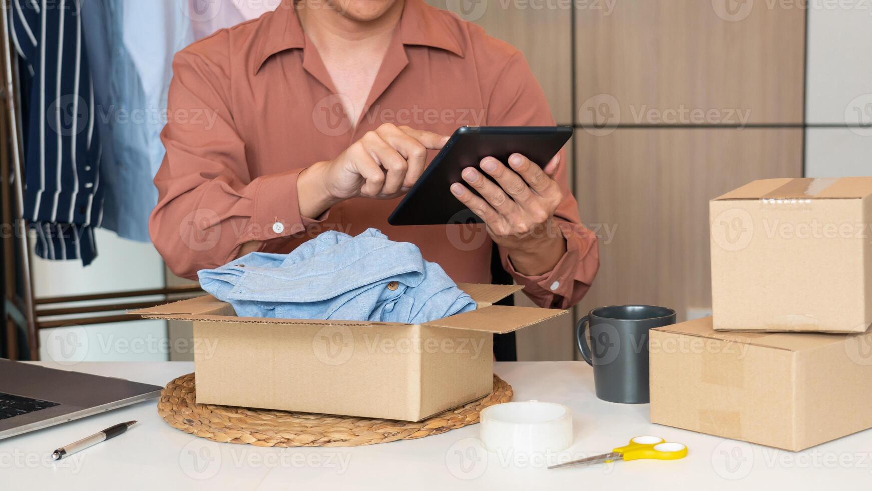 Asian business owner working at home with packing box of his online ... Asian business owner working at home with packing box of his online ...