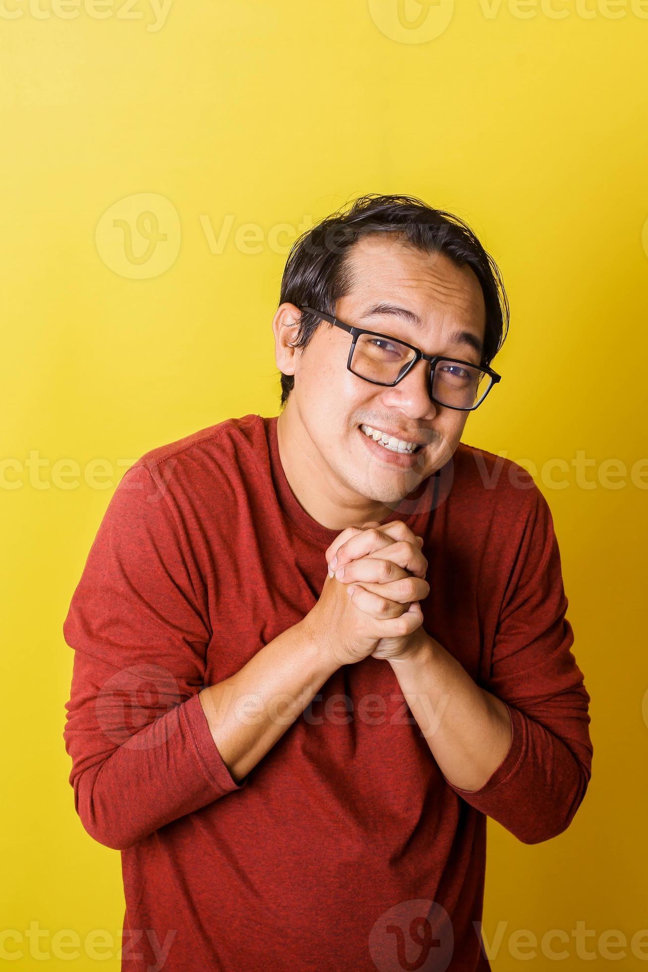 Casual man in glasses with pleading facial expression, pleading with ...