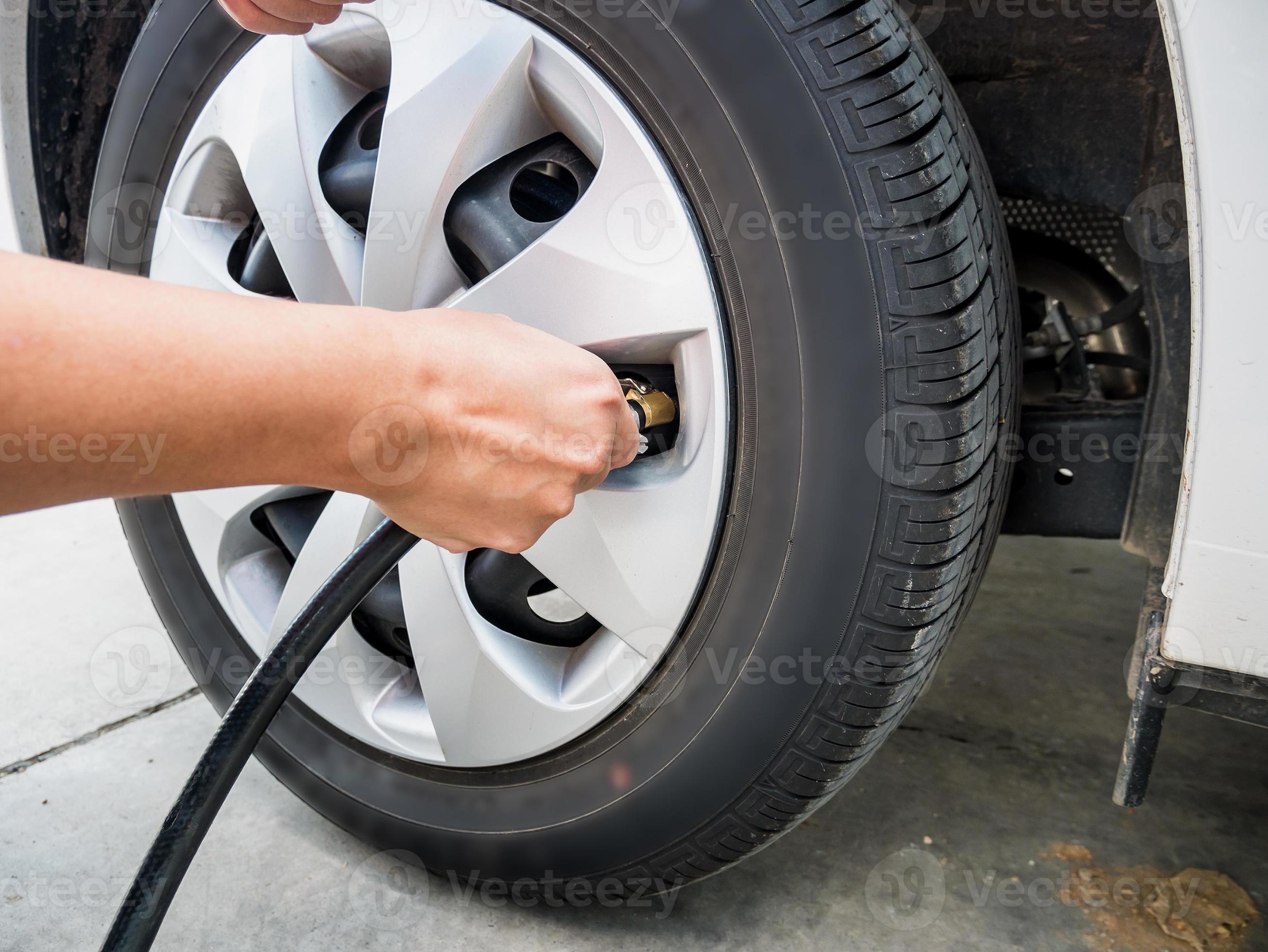 man filling air pressure in the car tyre 8130688 Stock Photo at Vecteezy