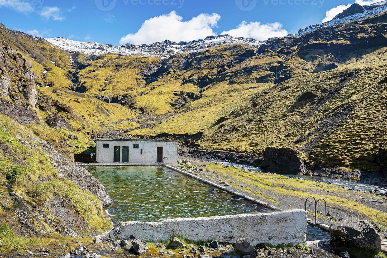 Beautiful Seljavallalaug natural geothermal hotspring pool against ... Beautiful Seljavallalaug natural geothermal hotspring pool against ...