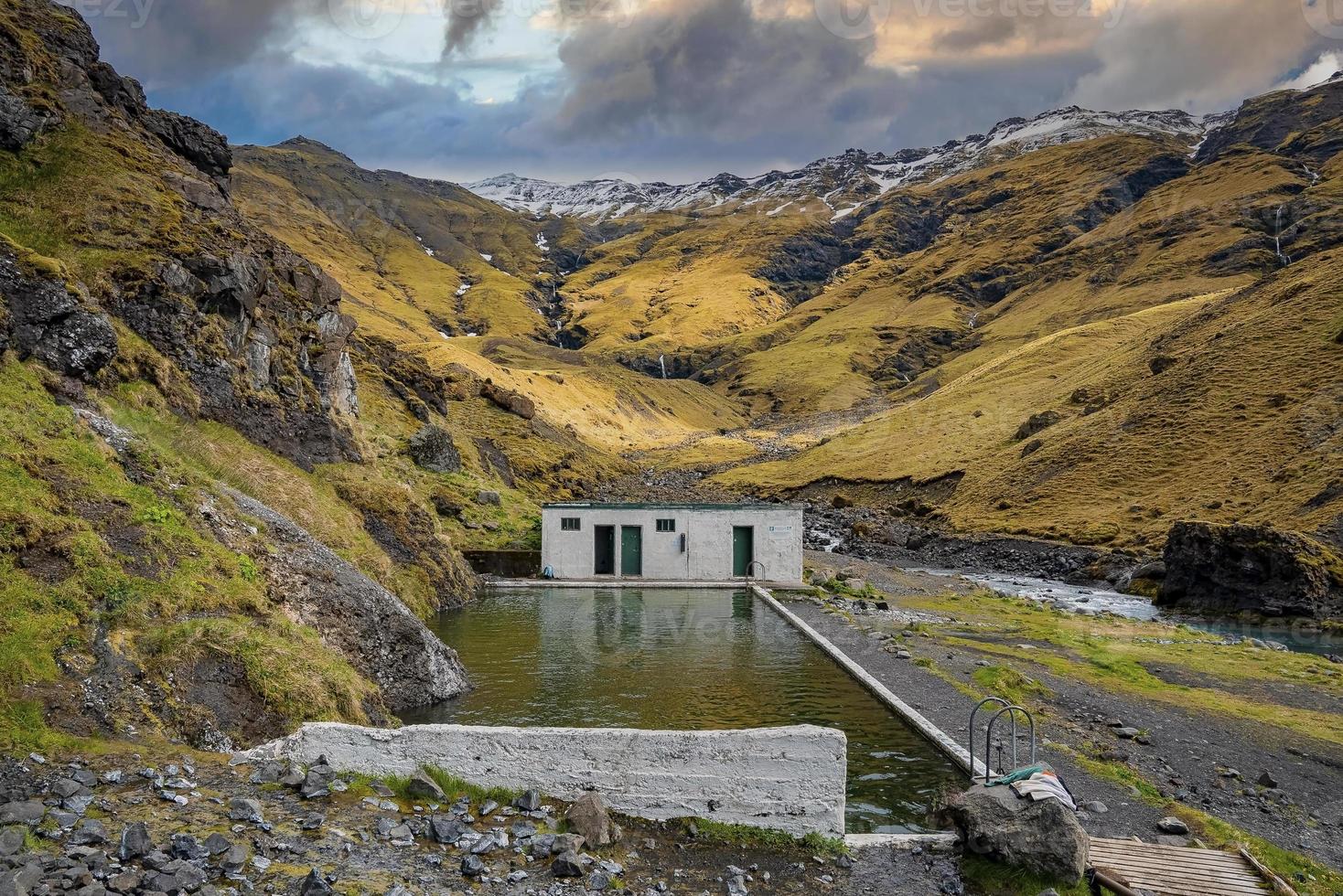 Scenic Seljavallalaug geothermal hotspring pool against mountains ... Scenic Seljavallalaug geothermal hotspring pool against mountains ...
