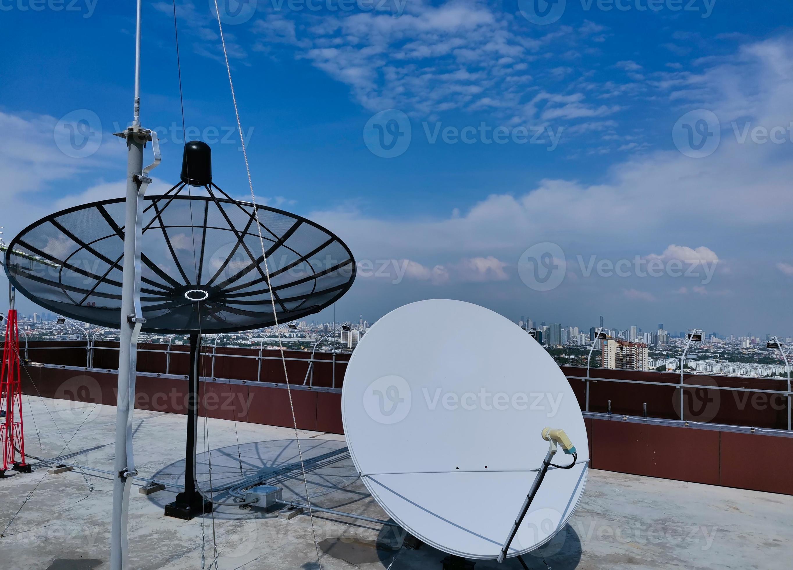A satellite dish is installed on the roof of a machine room on the top ...