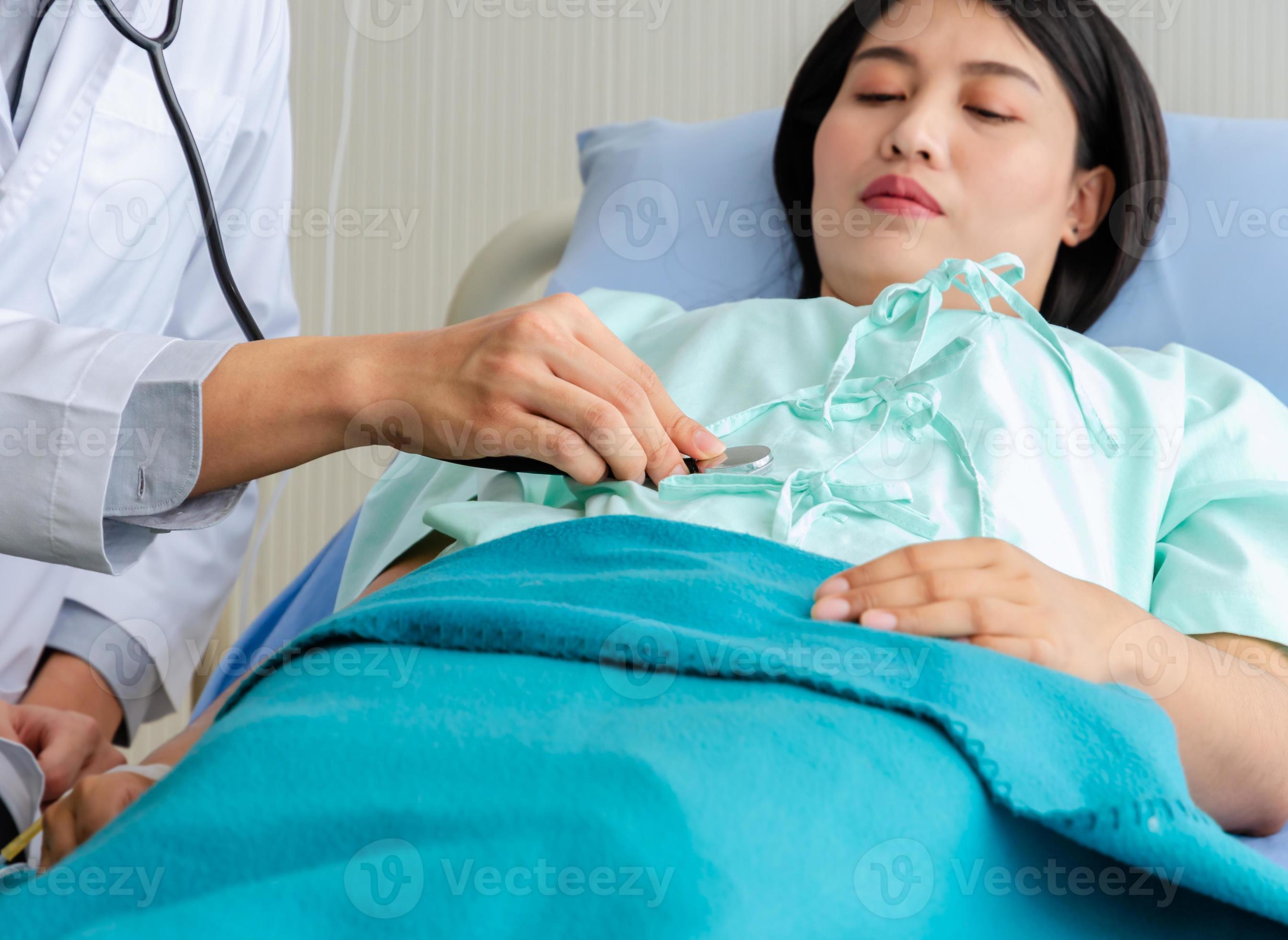 Male Doctor Examining Female Patient In Hospital Room 8203855 Stock